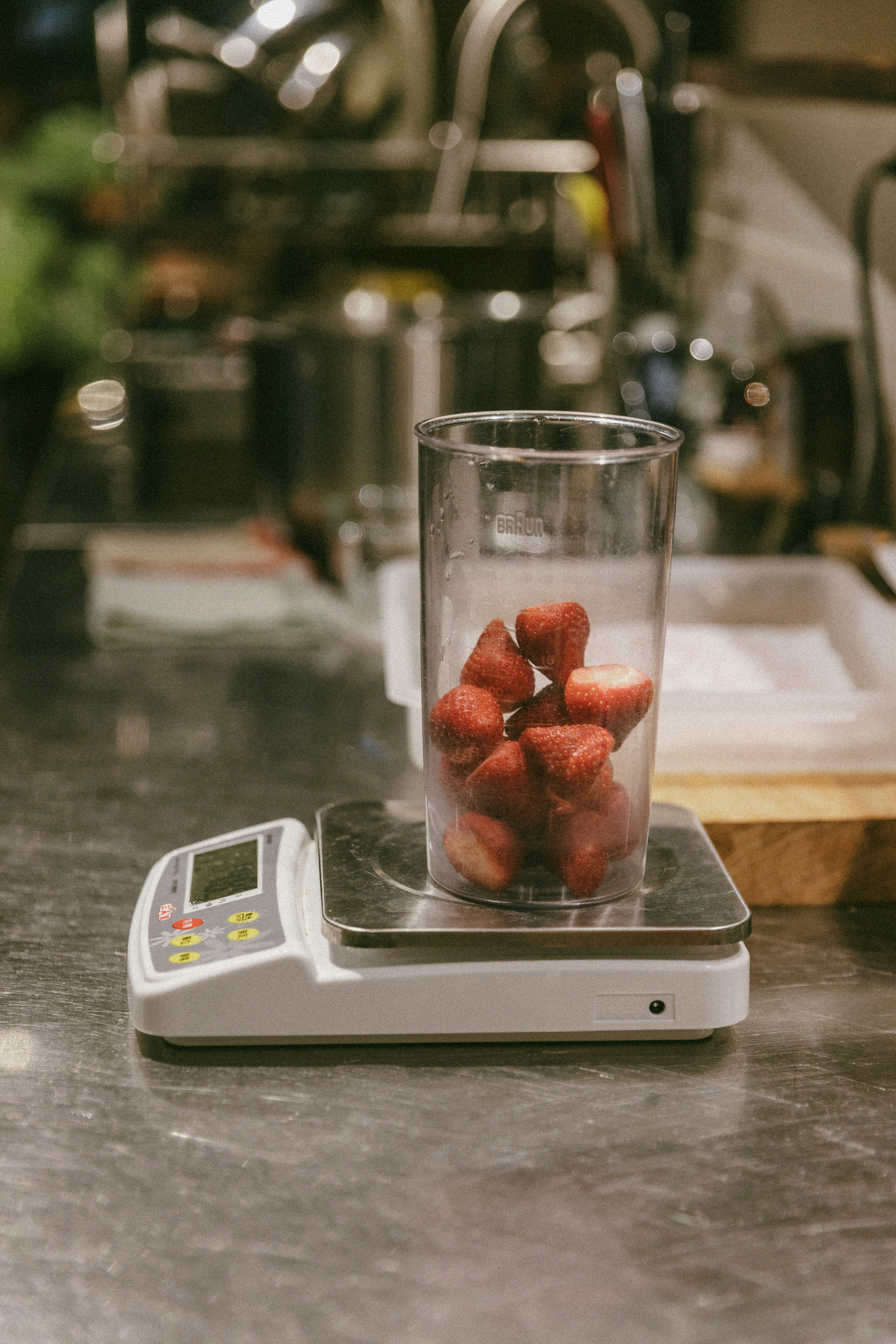 Strawberries in a measuring cup on a scale