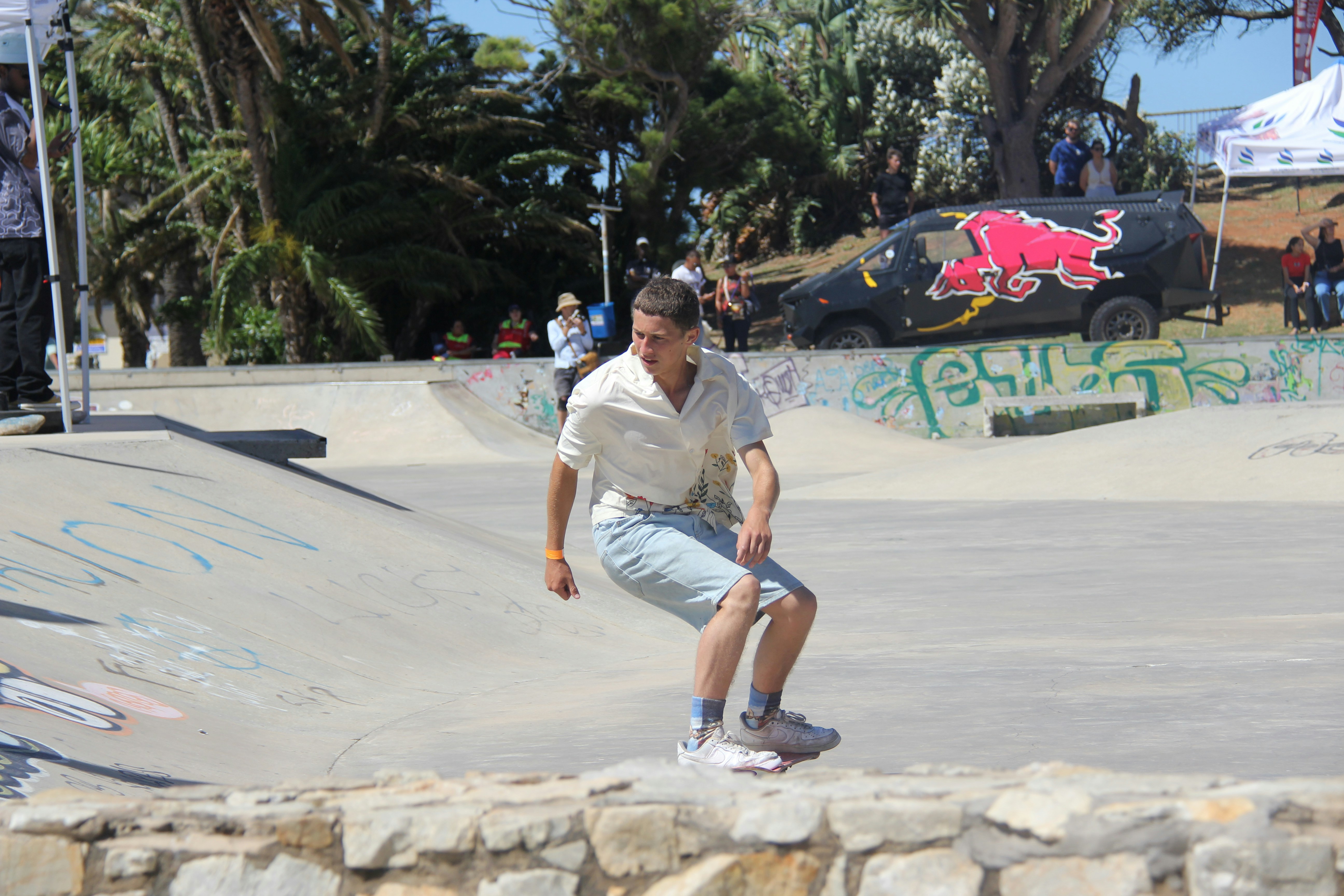 Skater in a sunlit bowl: mid-air drift above weathered concrete