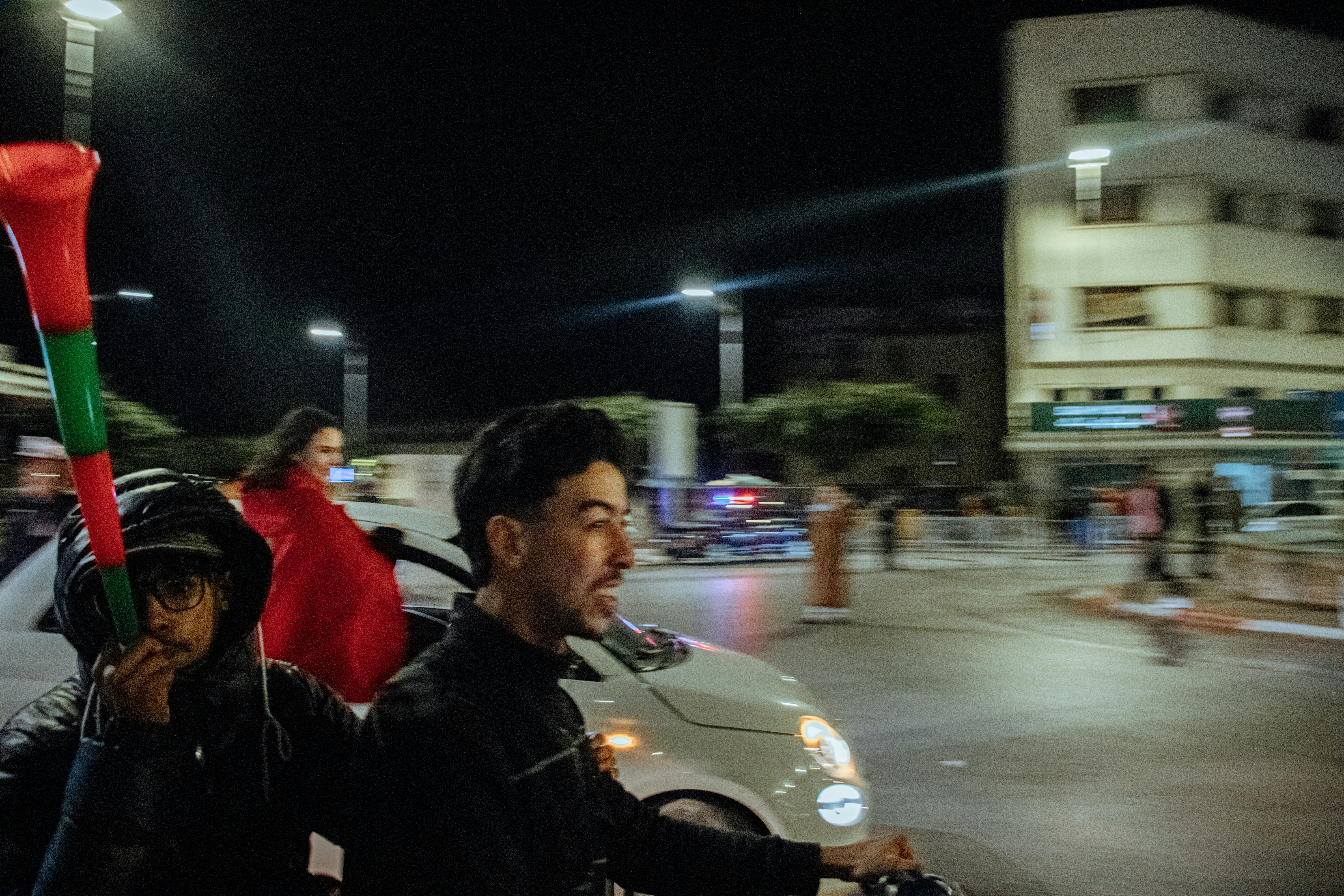 Night Ride in a Busy Square: Motion, Faces, and Neon Lights