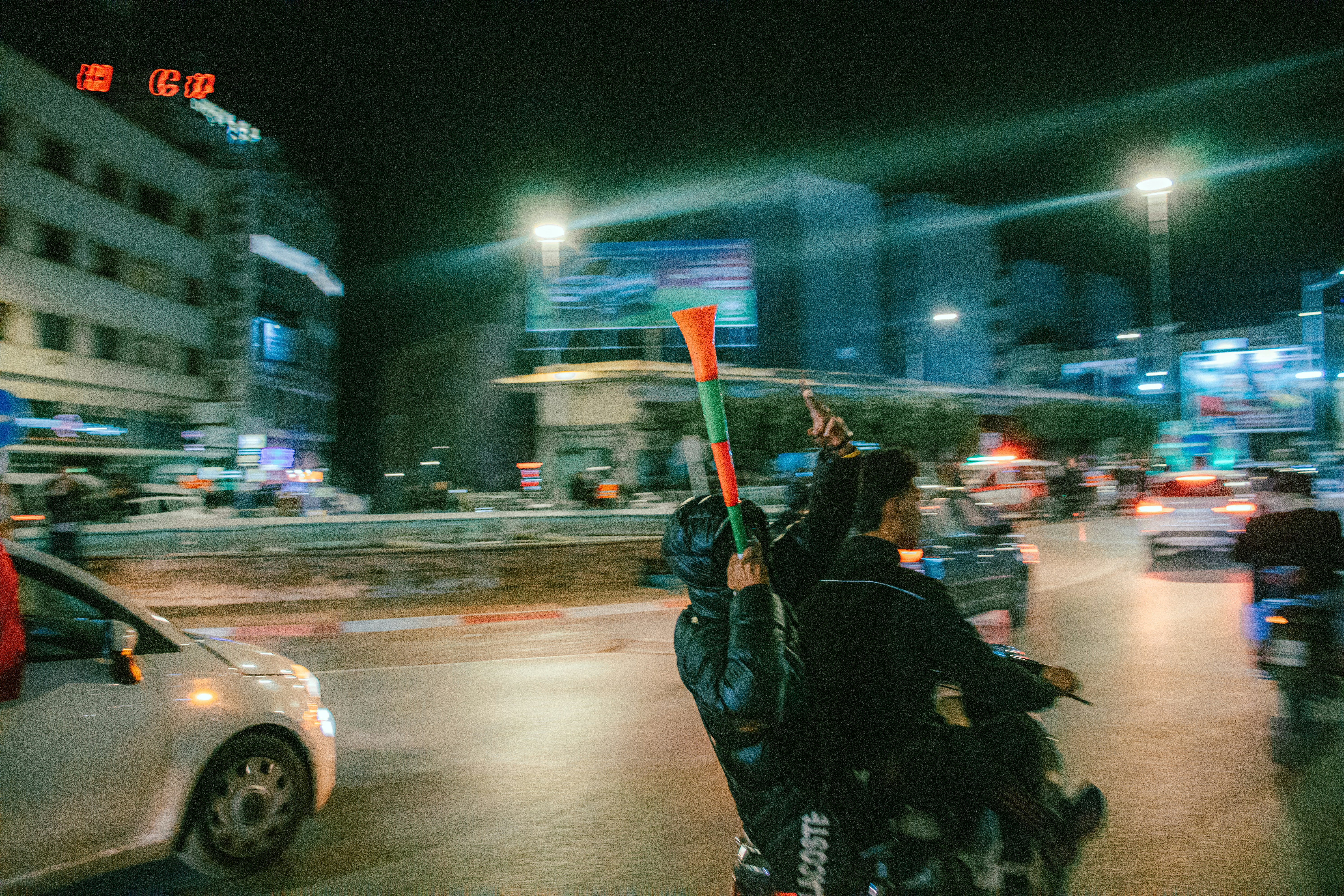 Midnight City Crossing: A Rider Flags the Way