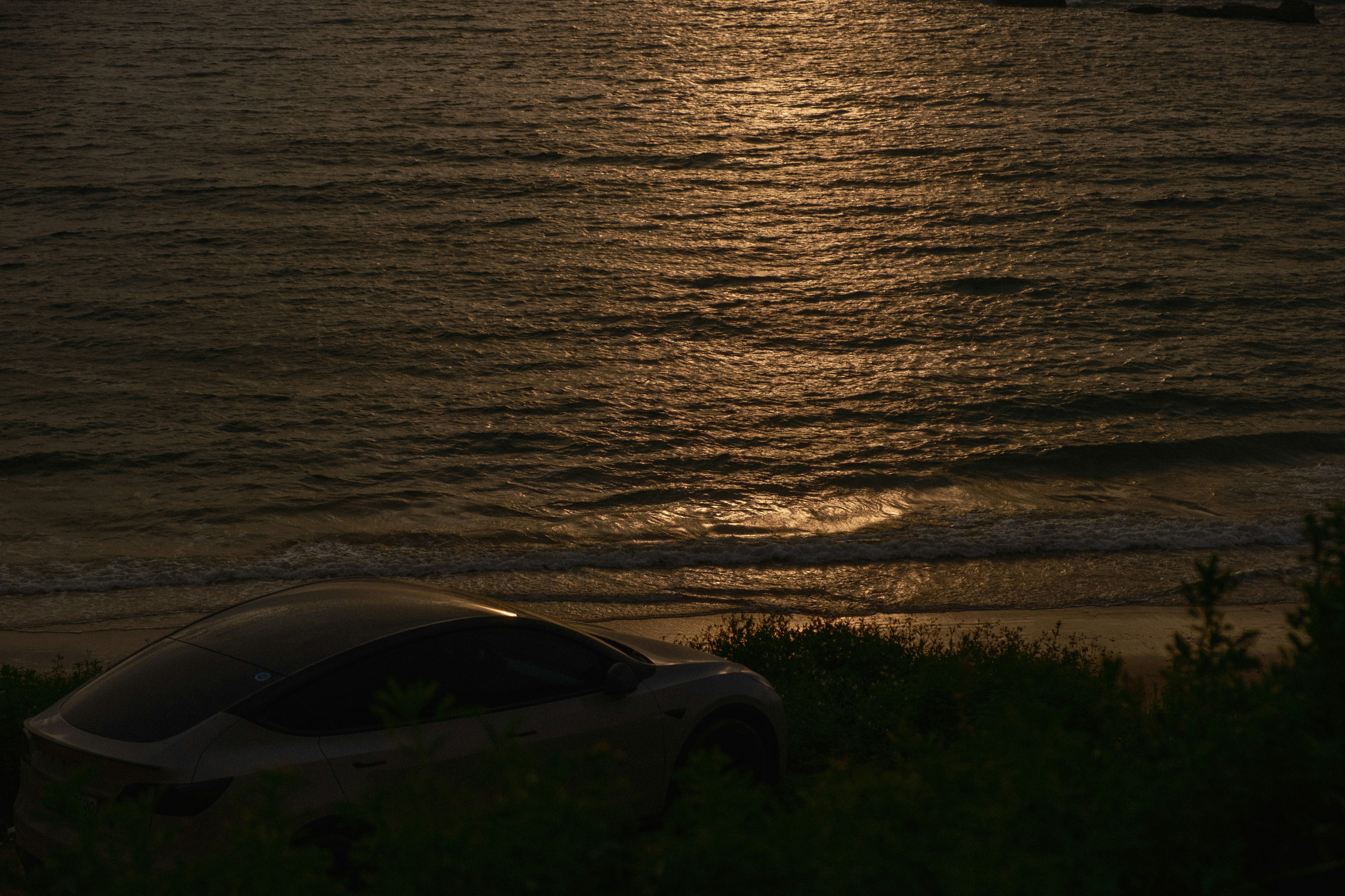 Sunset Drive: A Quiet Car Beside the Shimmering Sea