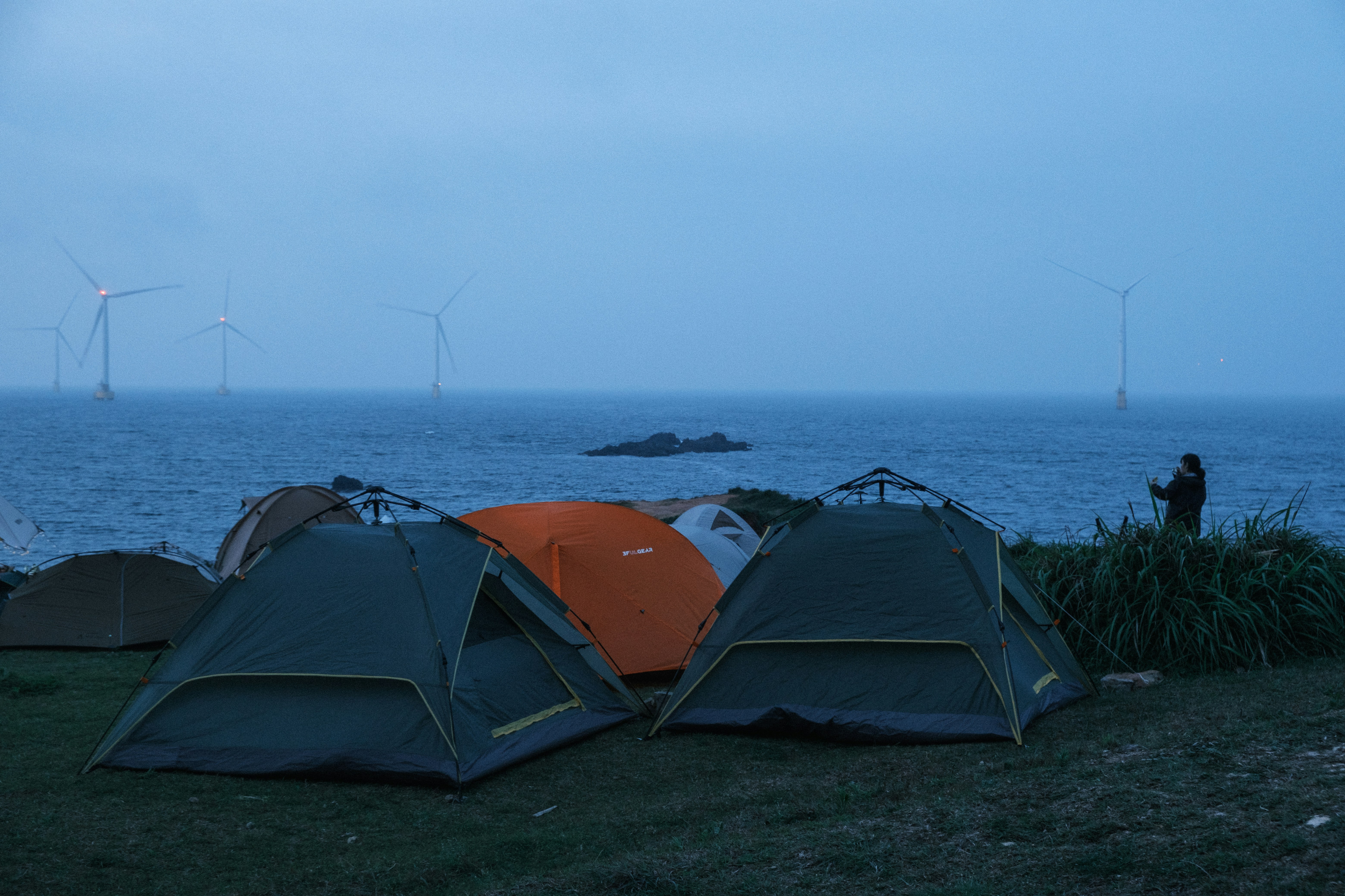 Cozy Campsite by the Distant Wind Farm at Dusk