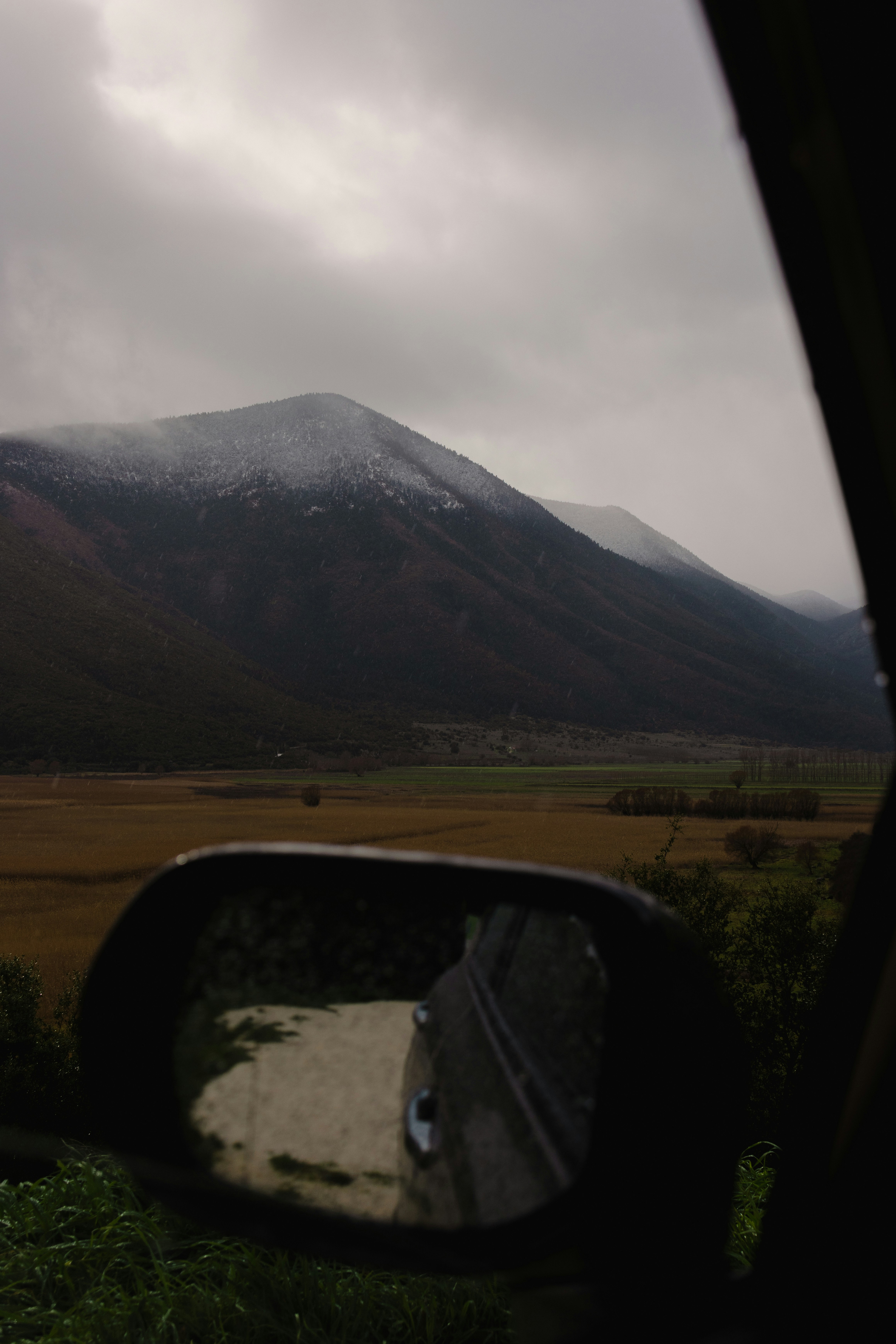Mountain Pass Reflected in a Car Window