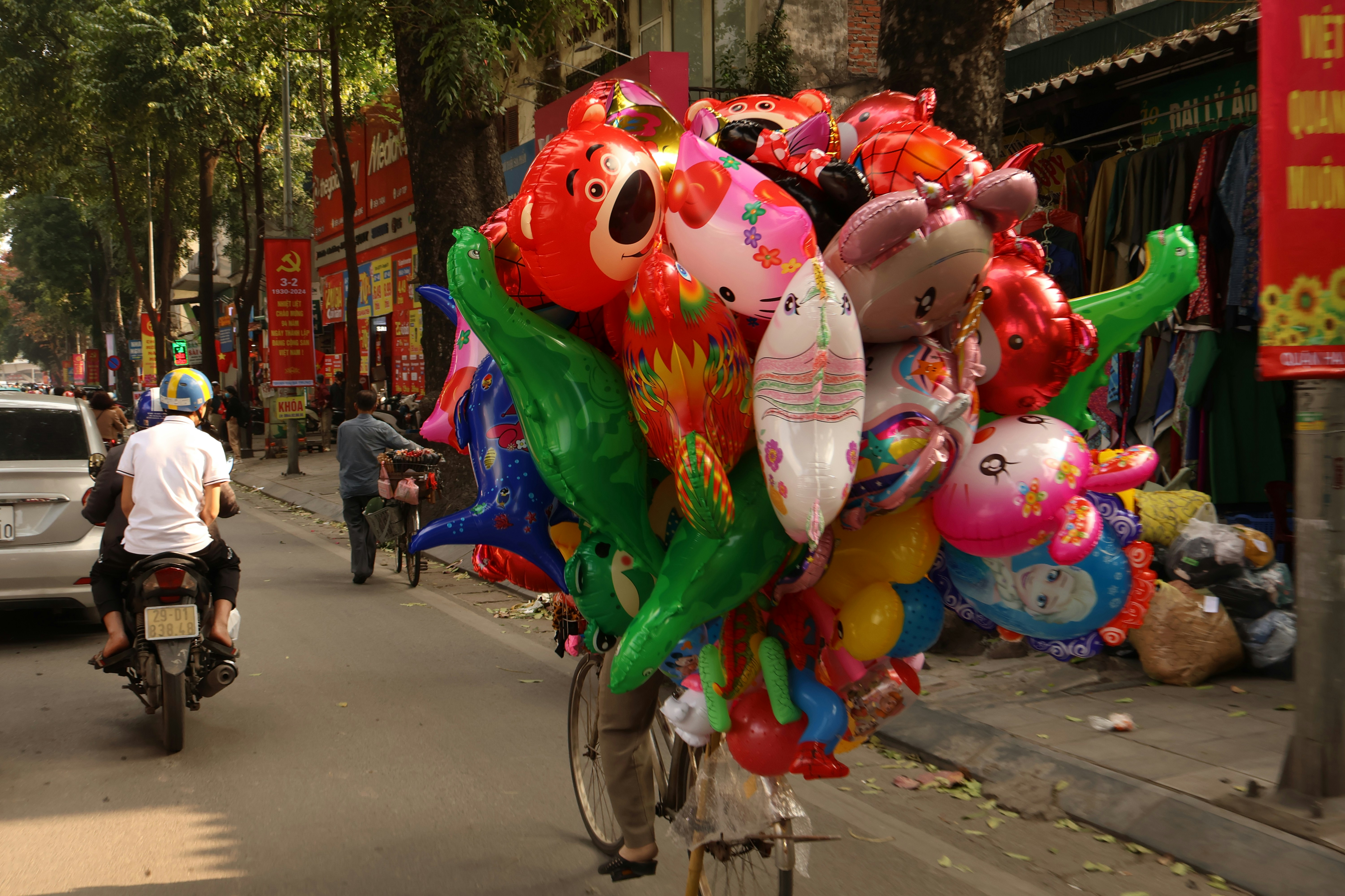 Floating Parade of Balloons in a Busy Street