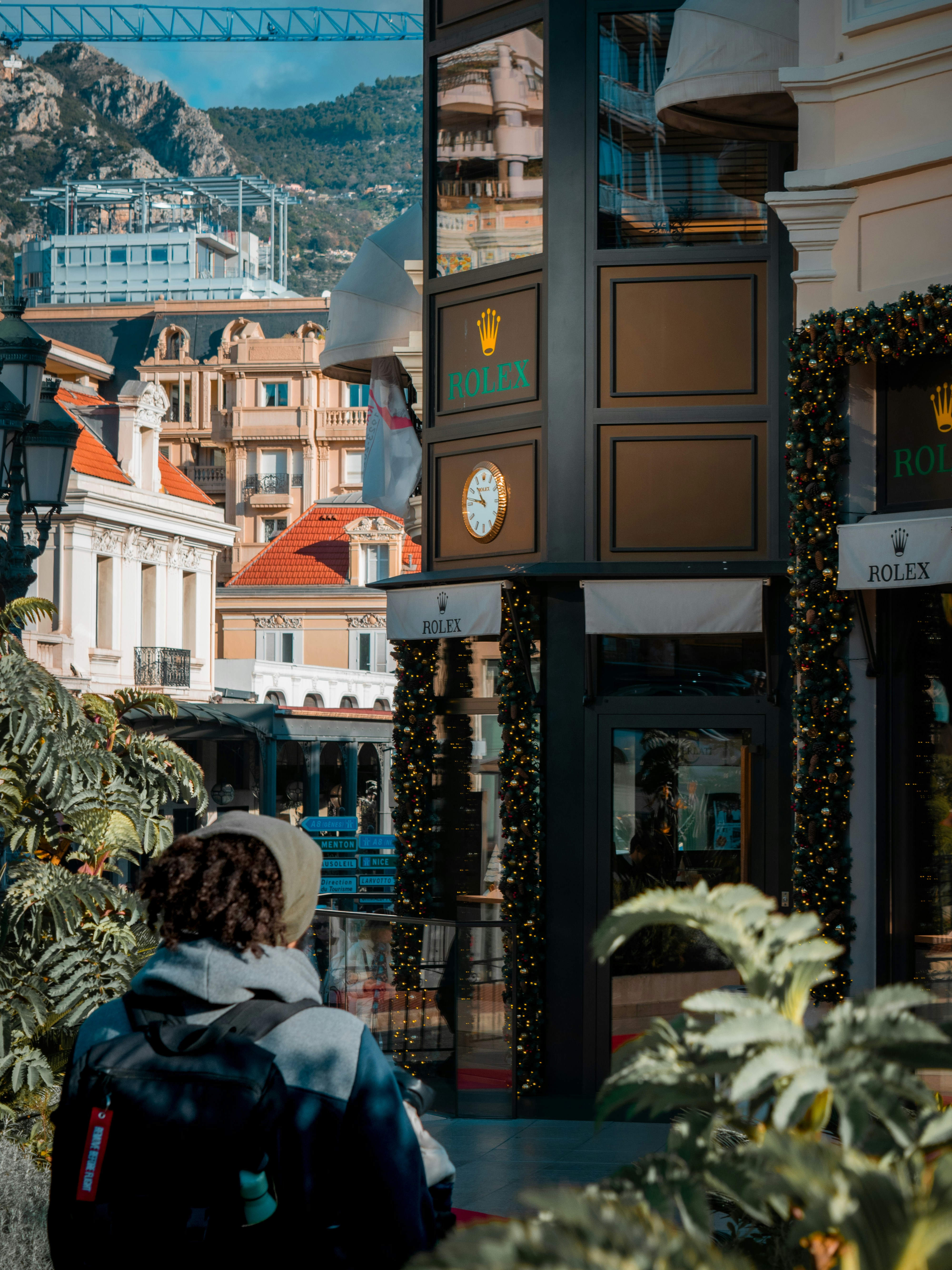 Rolex façade and sunlit streets of a luxury arcade