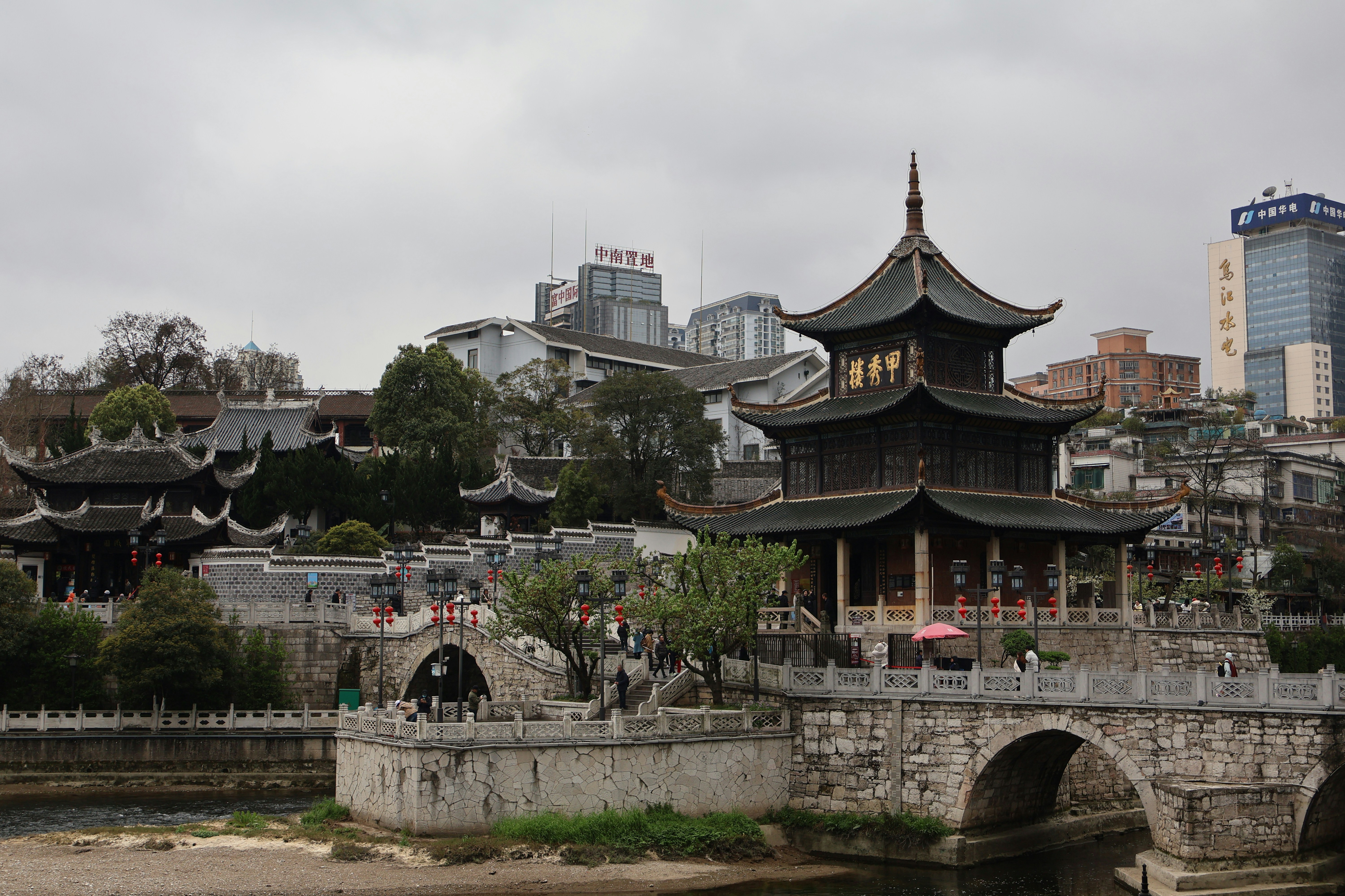 Pagoda by the River: A Traditional Chinese Temple Scene in a Modern Waterfront Quarter