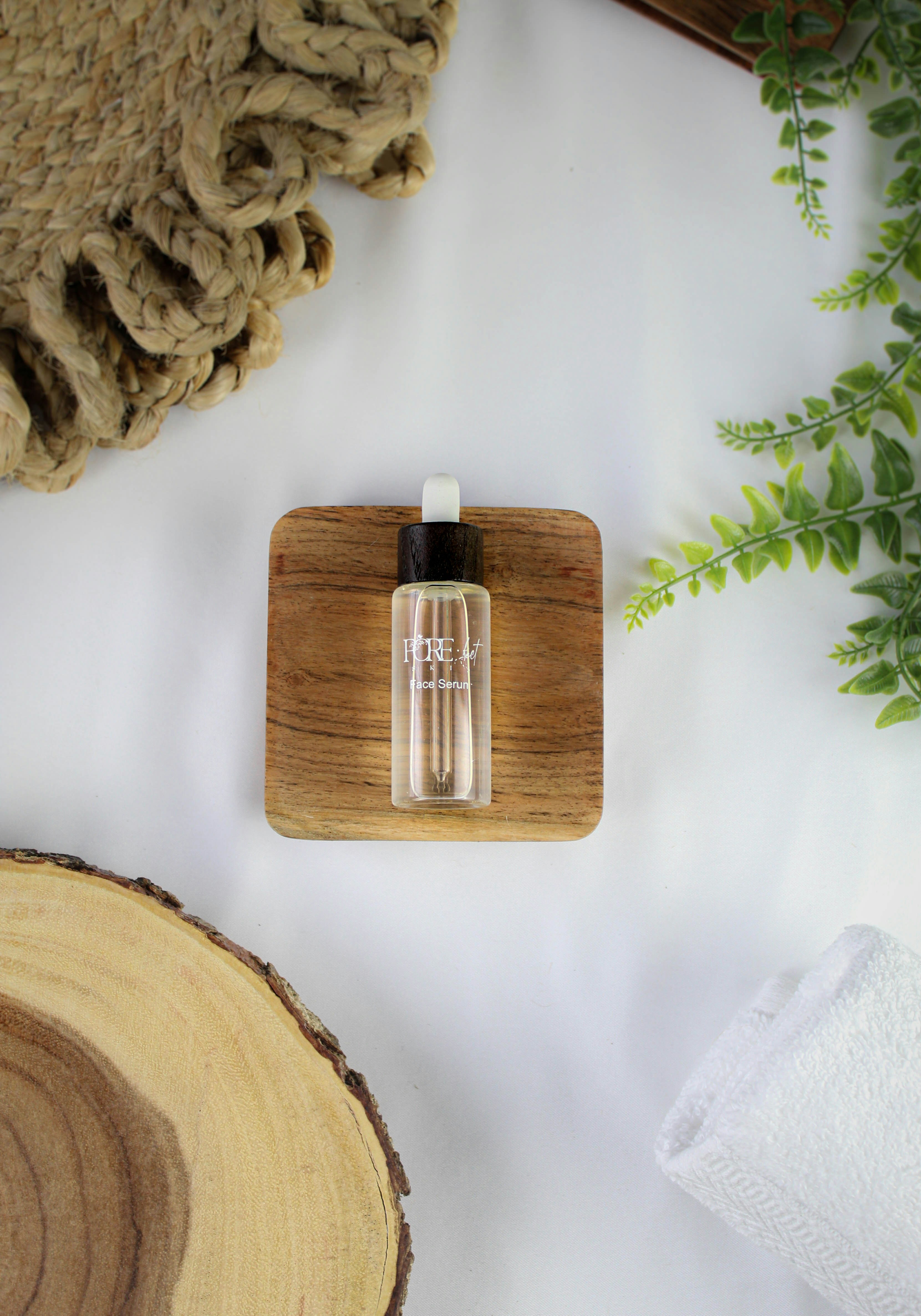 Tiny bottle of glow in a minimalist studio still life