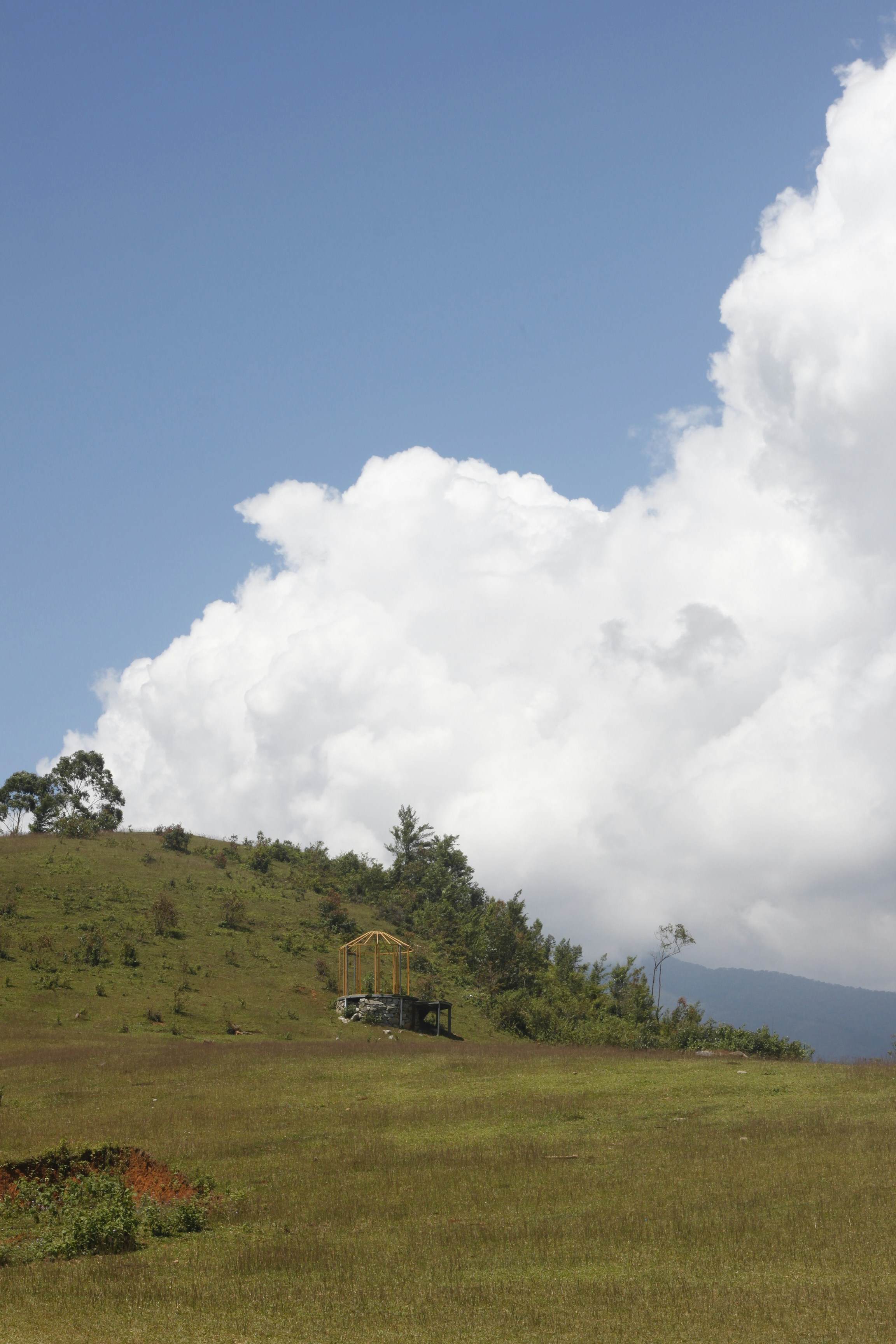 A Quiet Hilltop Gazebo Beneath a Sky-Riven Cloudscape