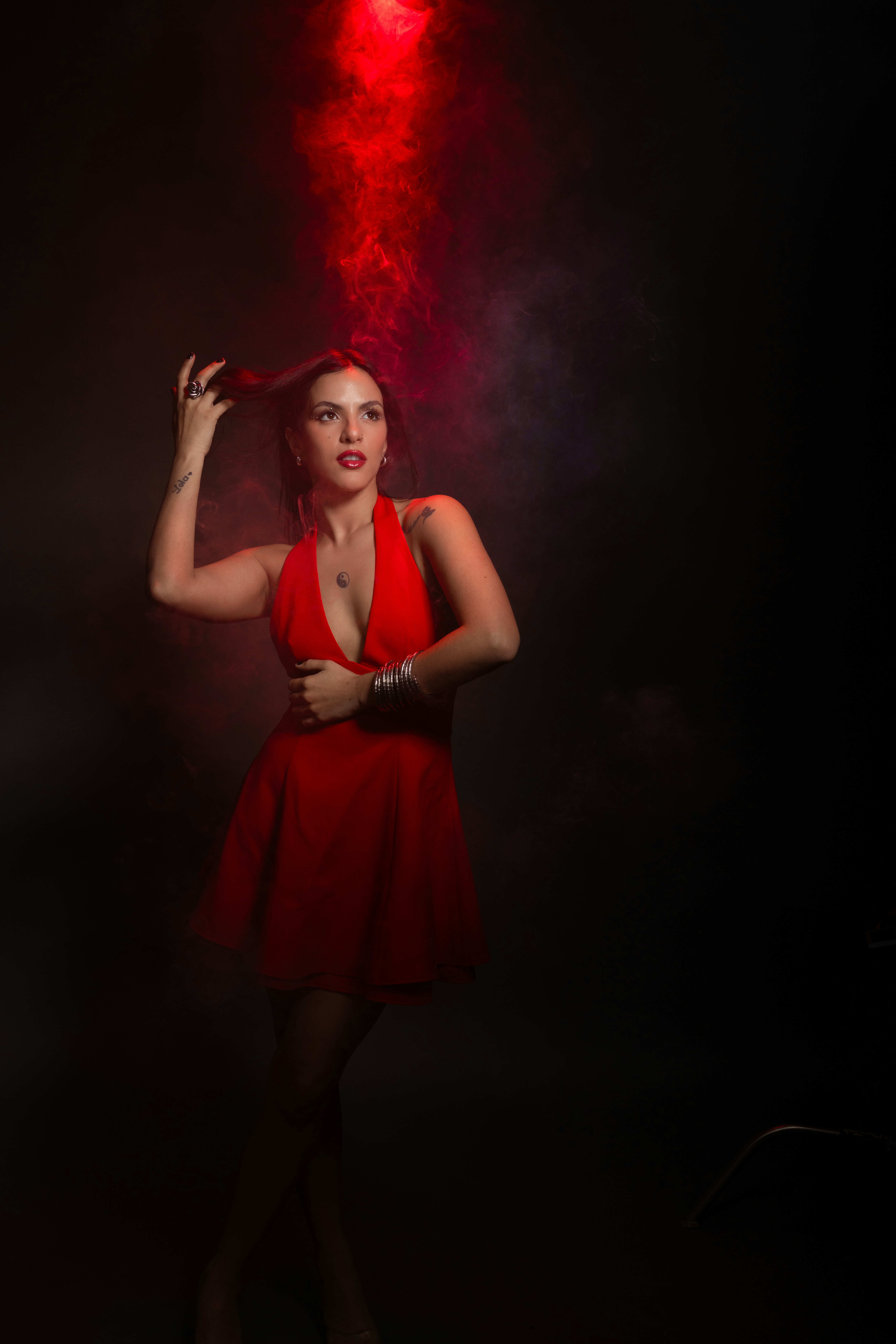 Red Velvet Spotlight: A Confident Pose Within the Smoke
