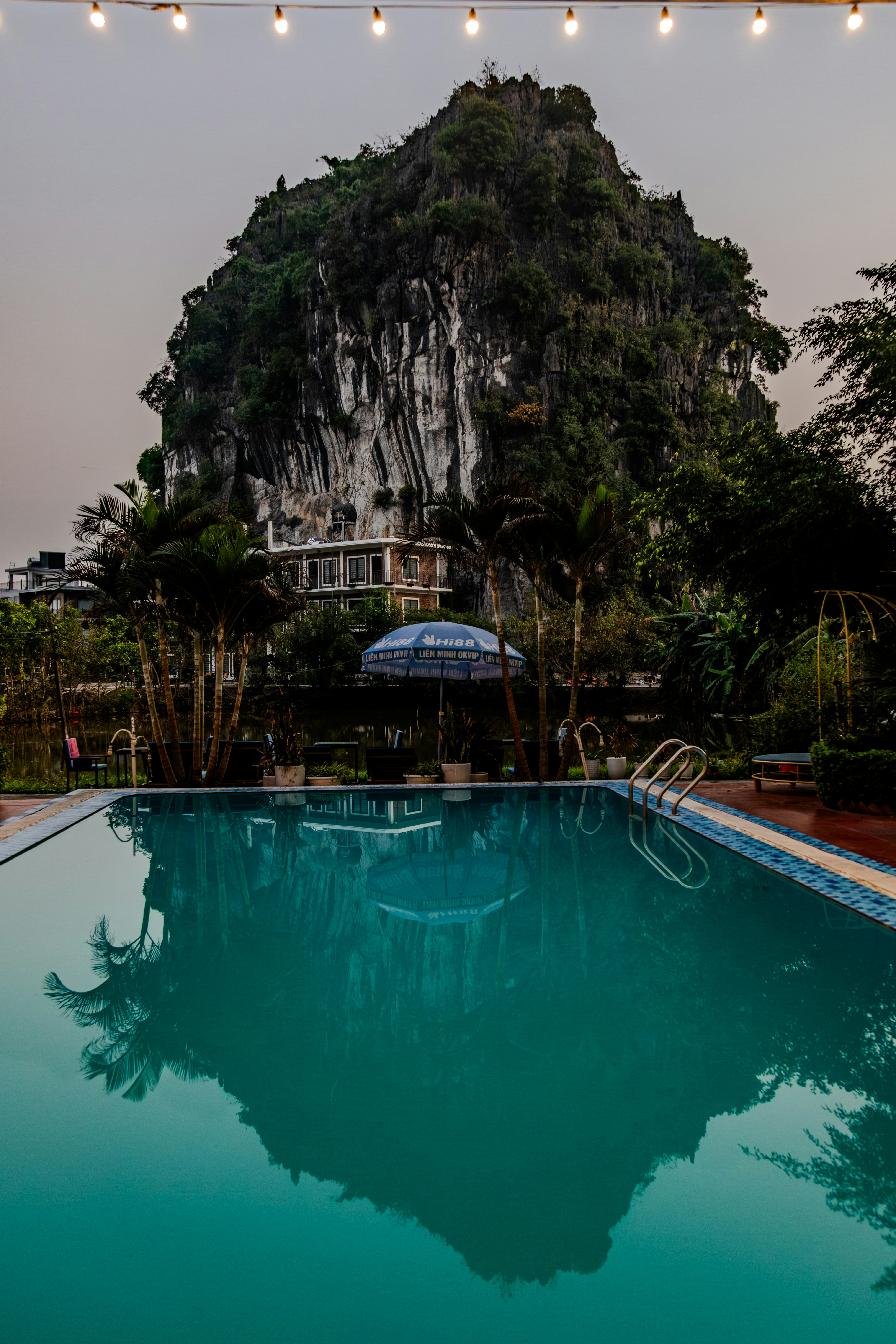 Poolside Oasis Framed by a Vertical Mountain