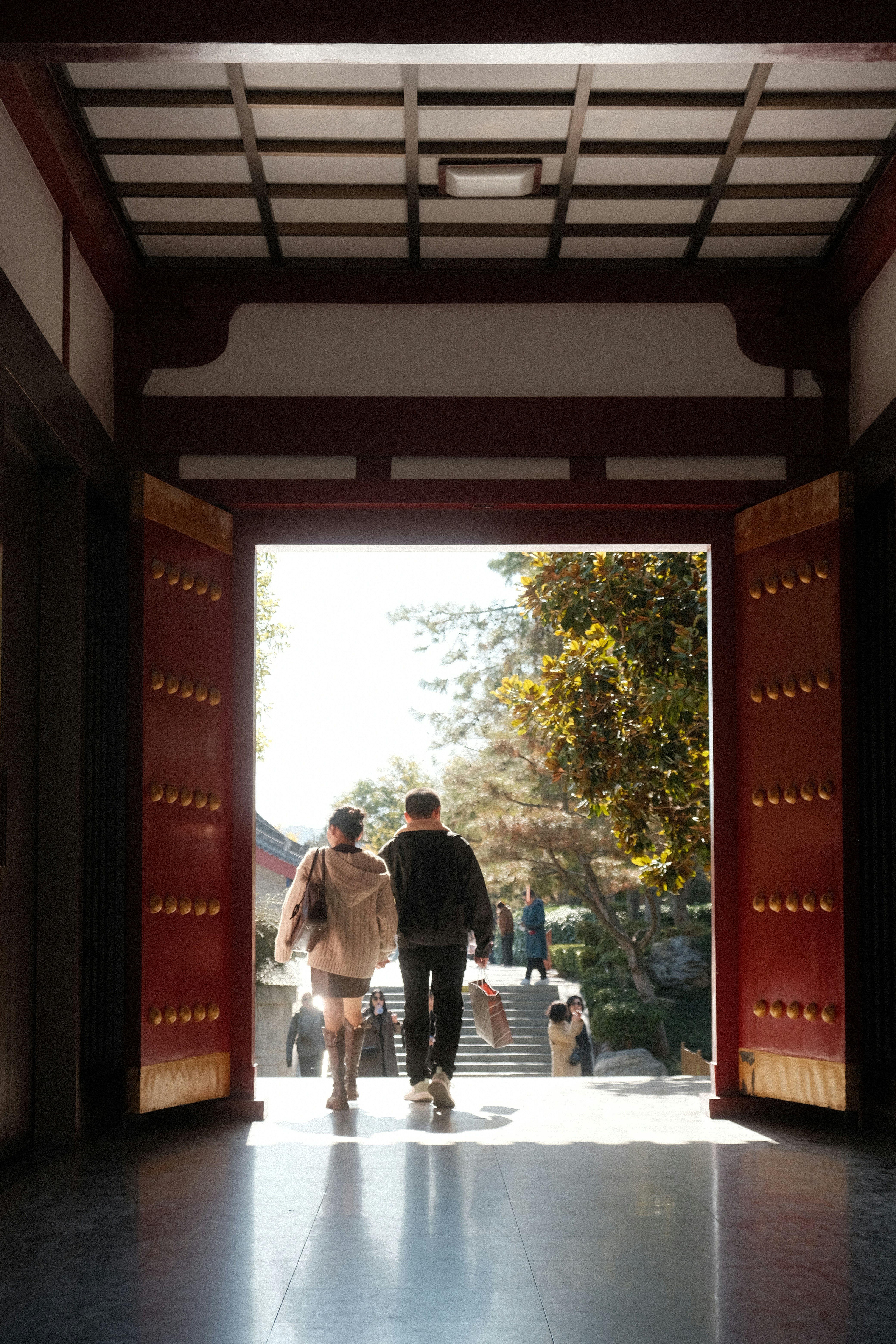 Portal to a Quiet Terrace: Figures Walking Toward the Light
