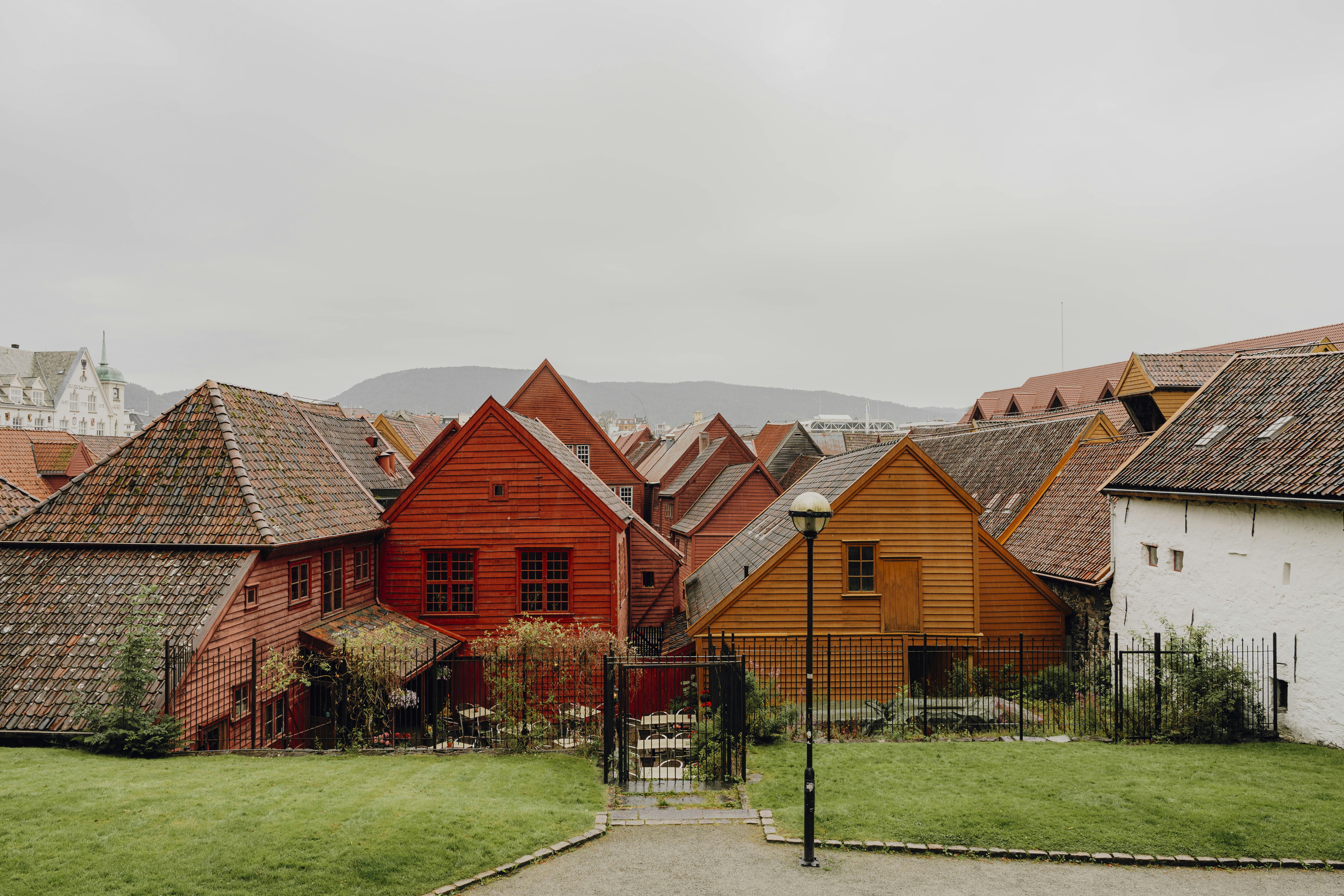 Row of Colorful Timbered Cabins Framed by a Quiet Lawn