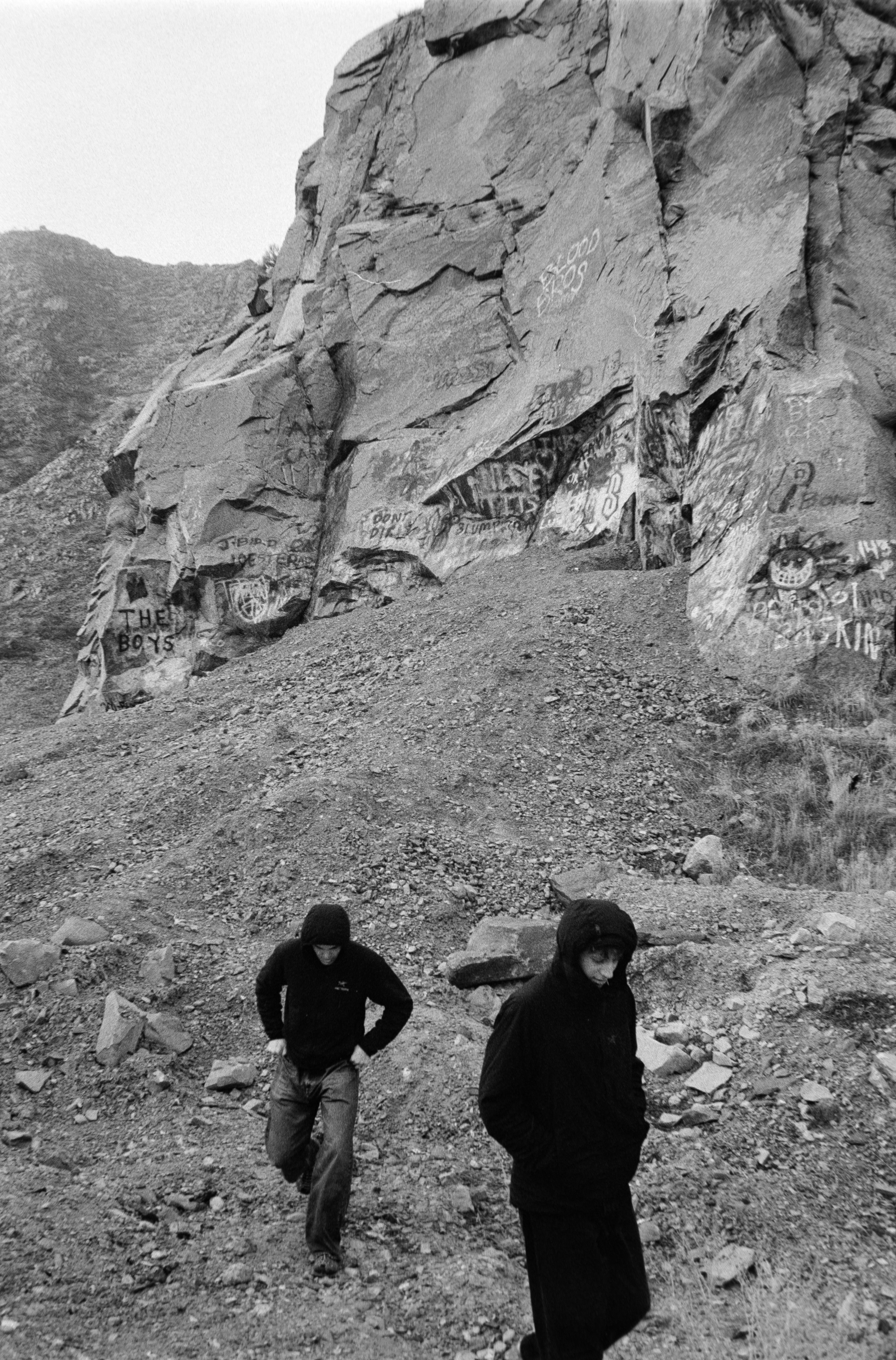 Two Hikers in a Graffiti-Strewn Quarry