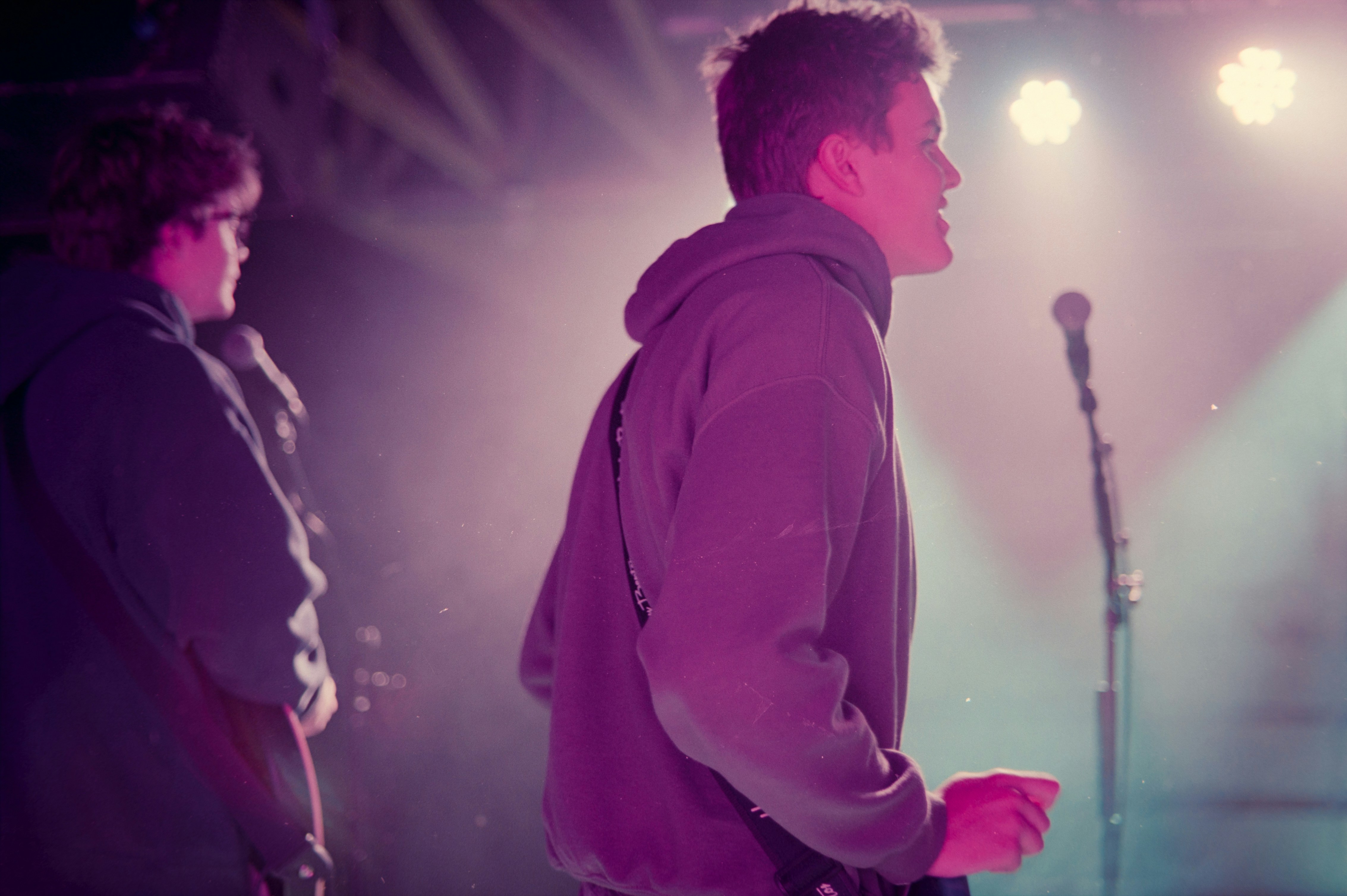 Mid‑Stage Momentum: A Singer in Focus Beneath Neon Haze