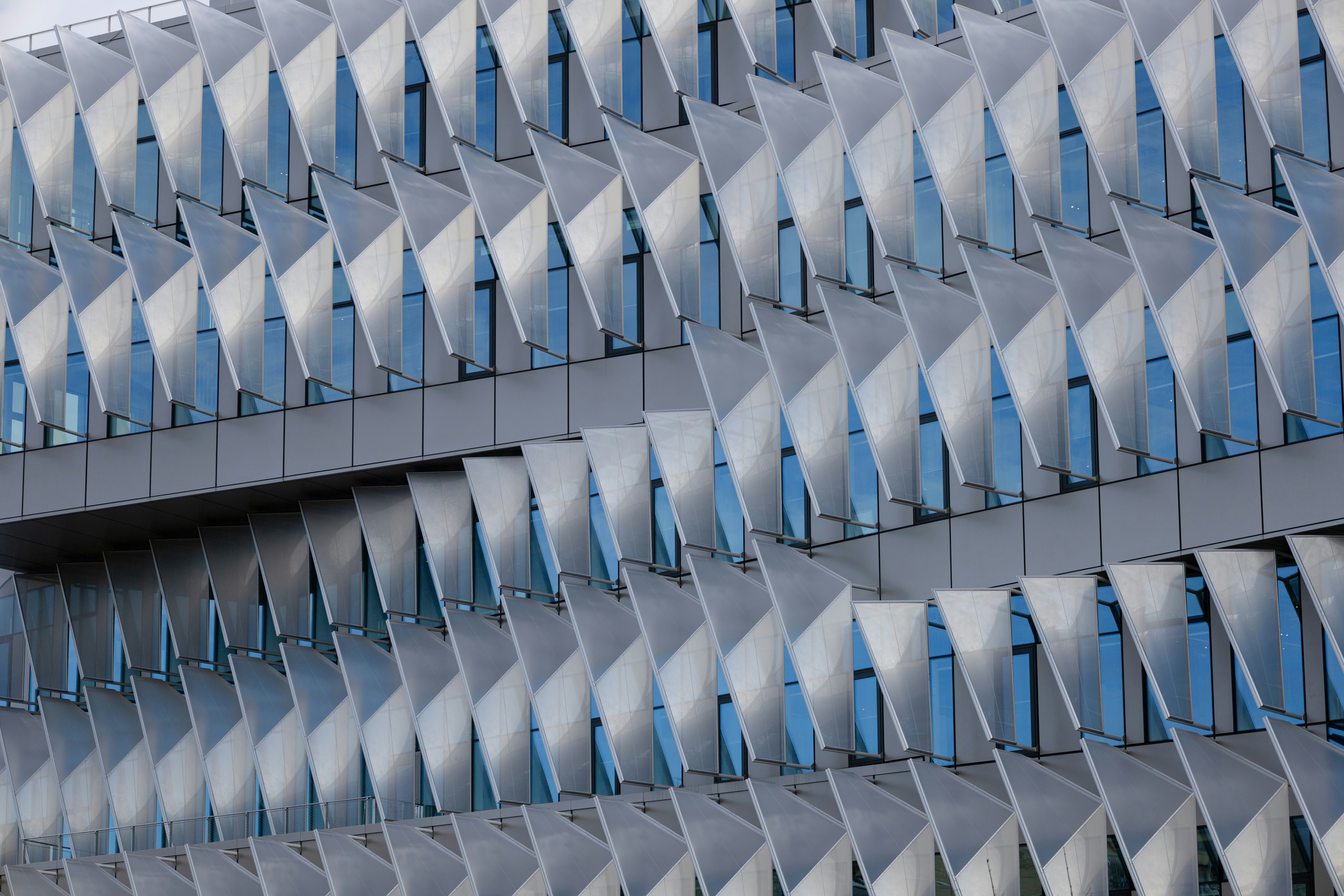 Modern building facade with geometric patterns and windows. photo ...