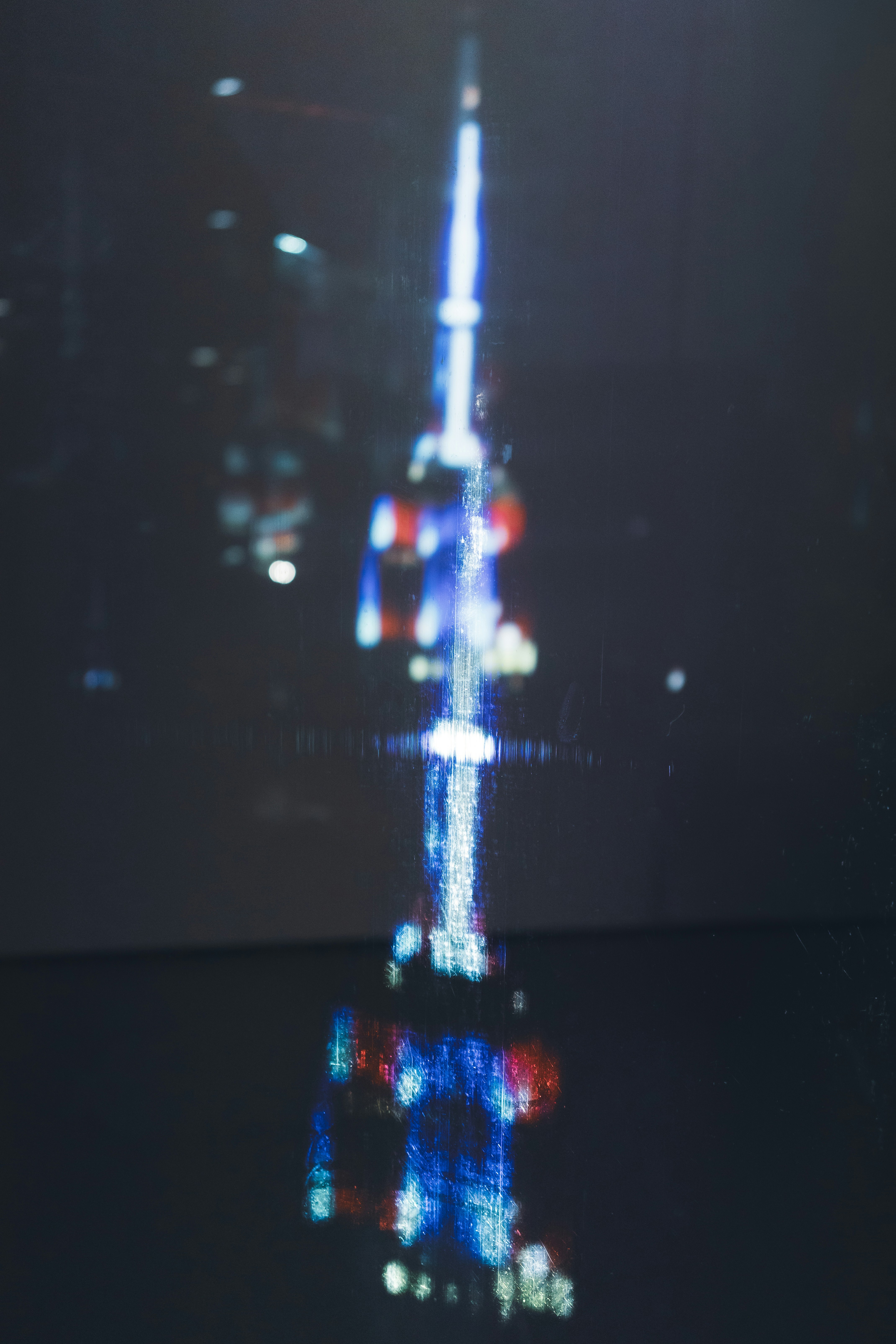 Neon Tower in Motion: A Blur of Night Lights
