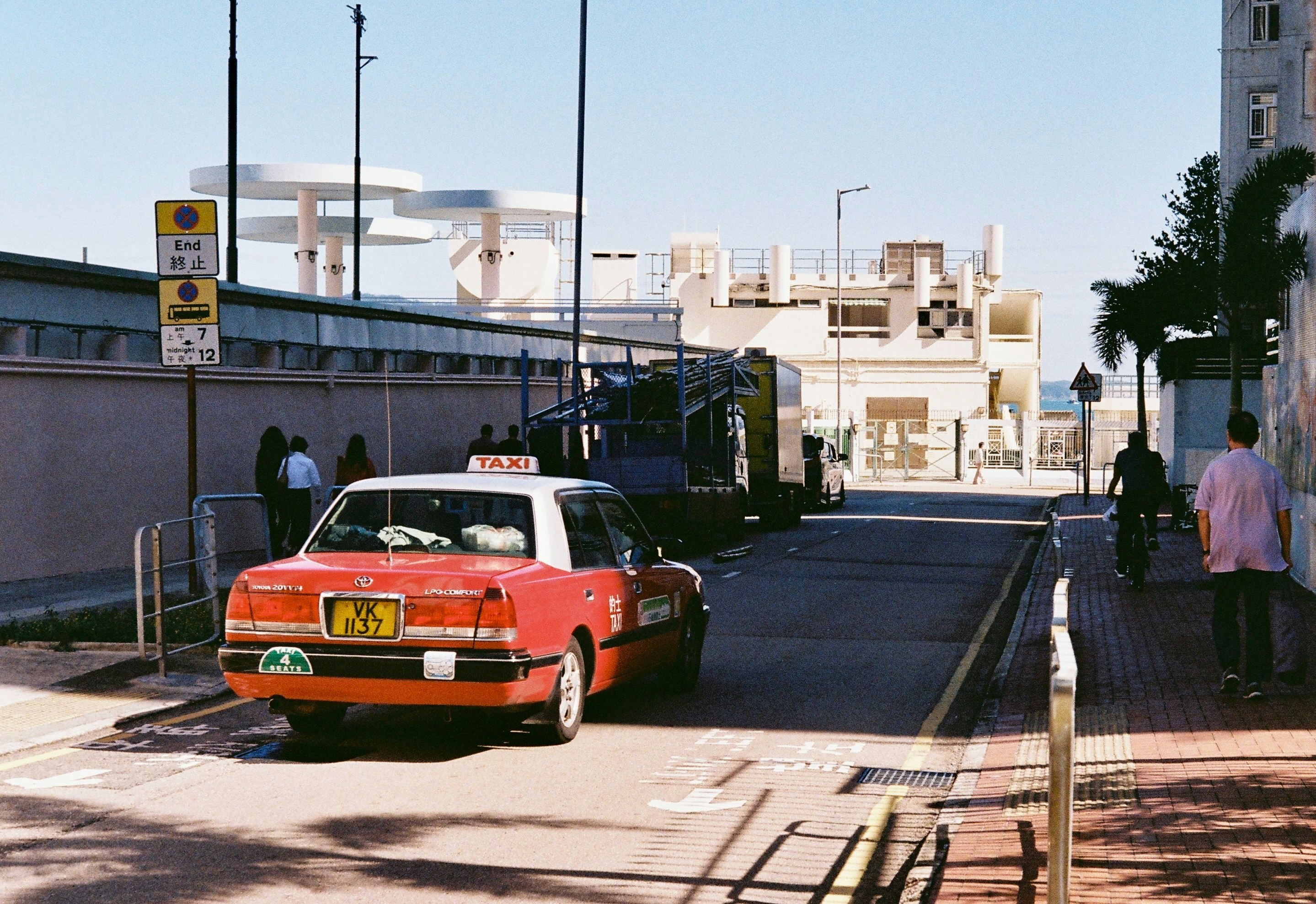 Taxi at the Corner: Sunset Street in a Quiet City Block