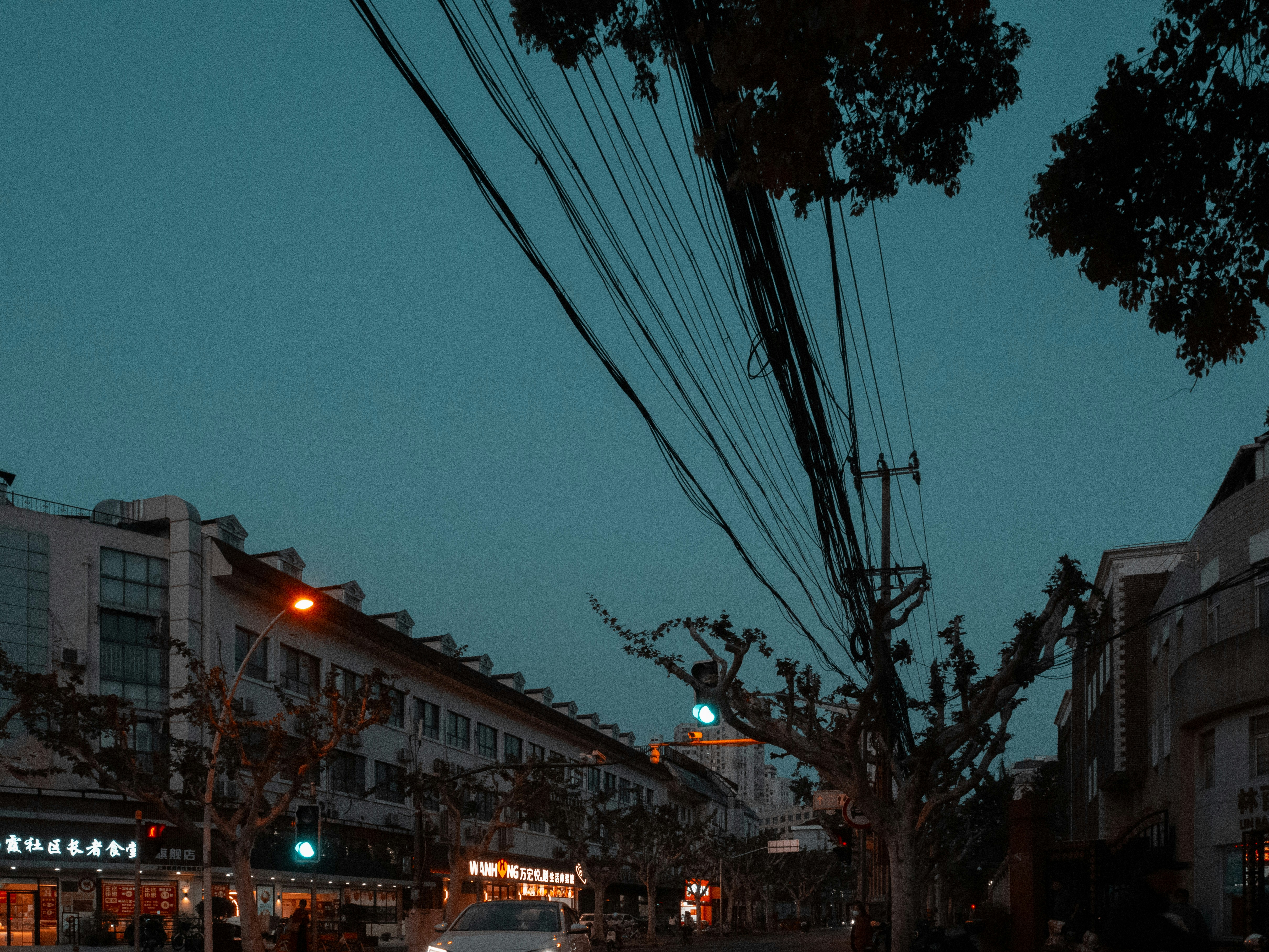 Street scene with power lines and buildings at dusk