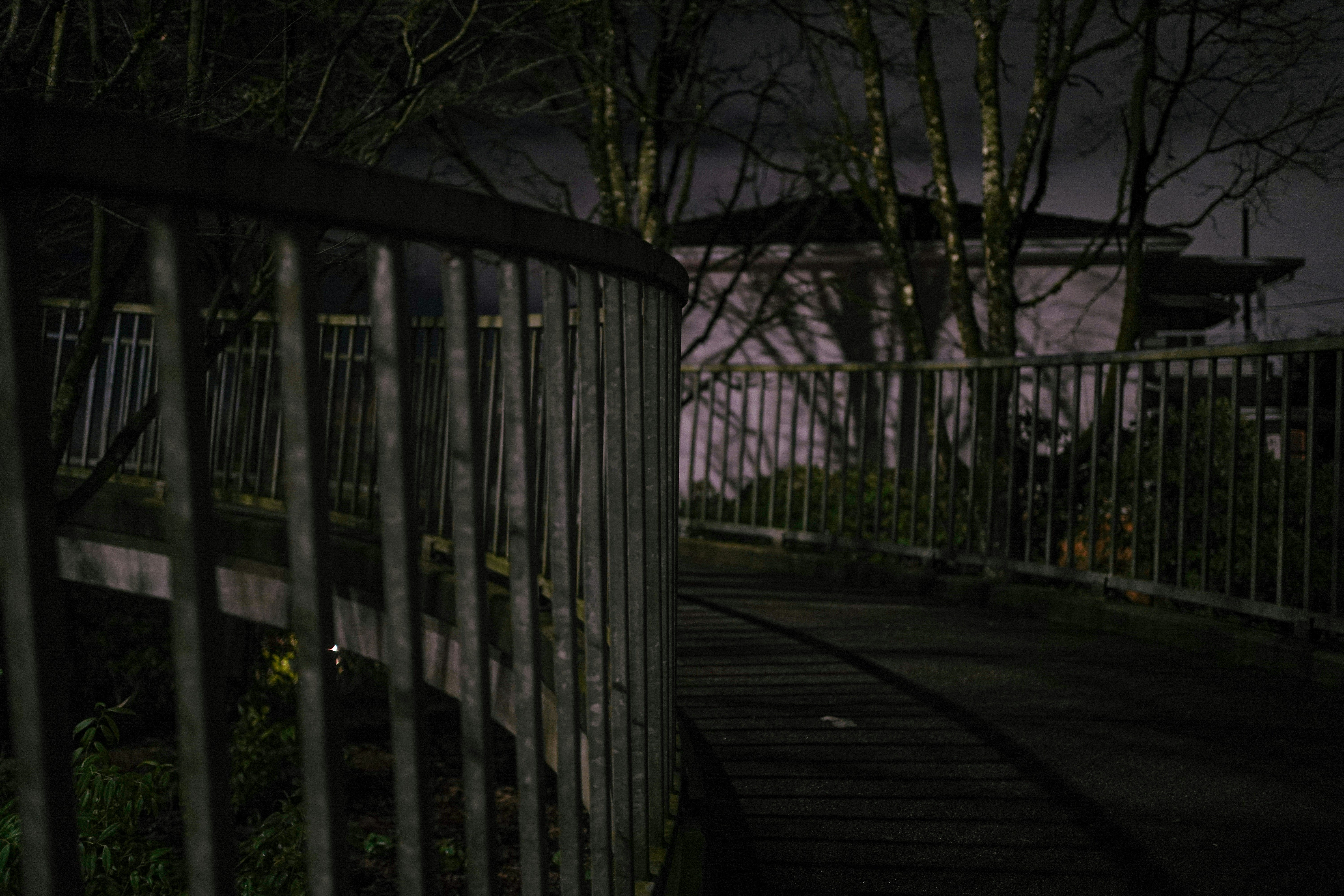 Moonlit railing curve: a quiet urban nighttime walk
