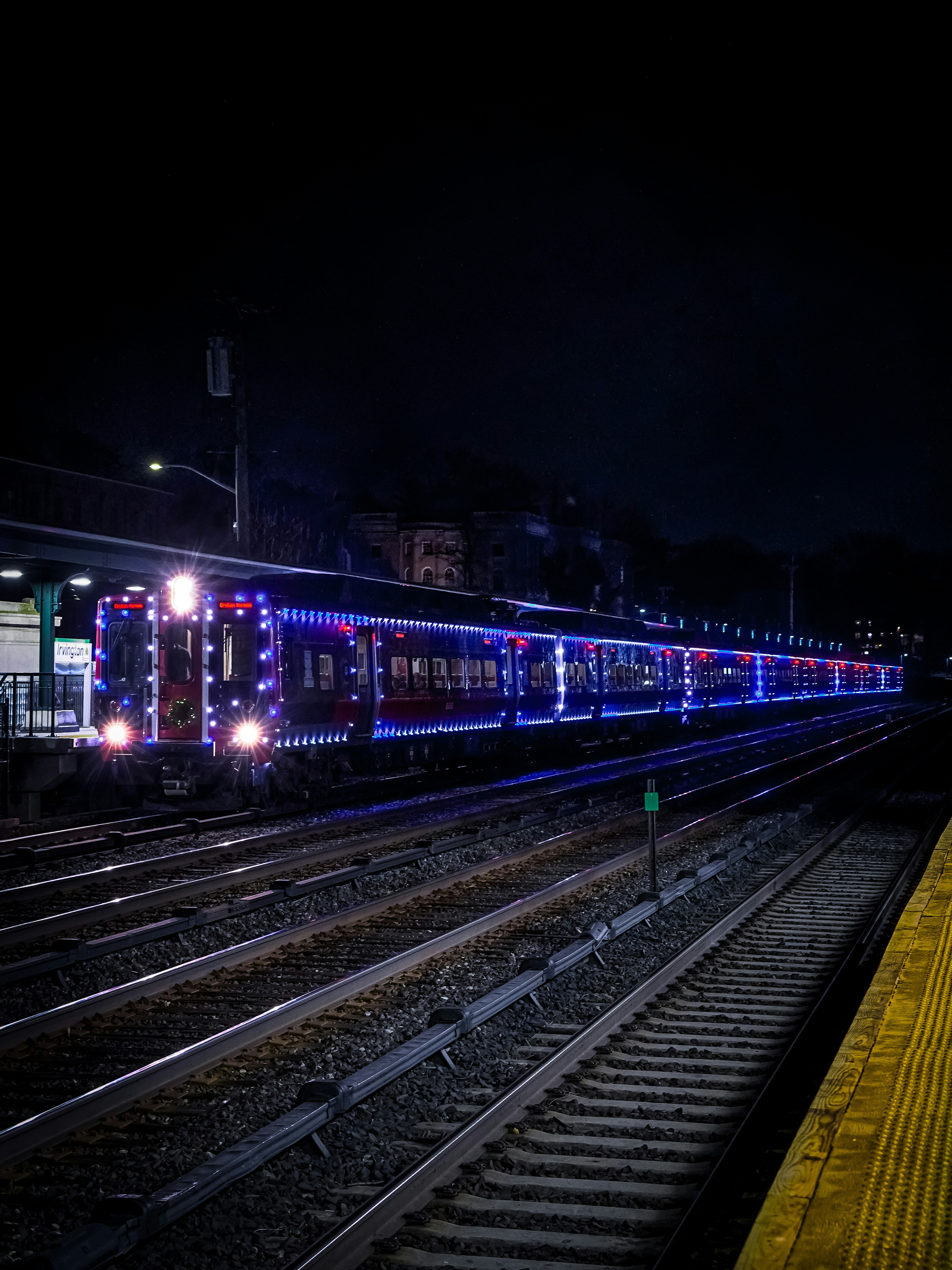 Neon-laced Night Train Tracing the Tracks