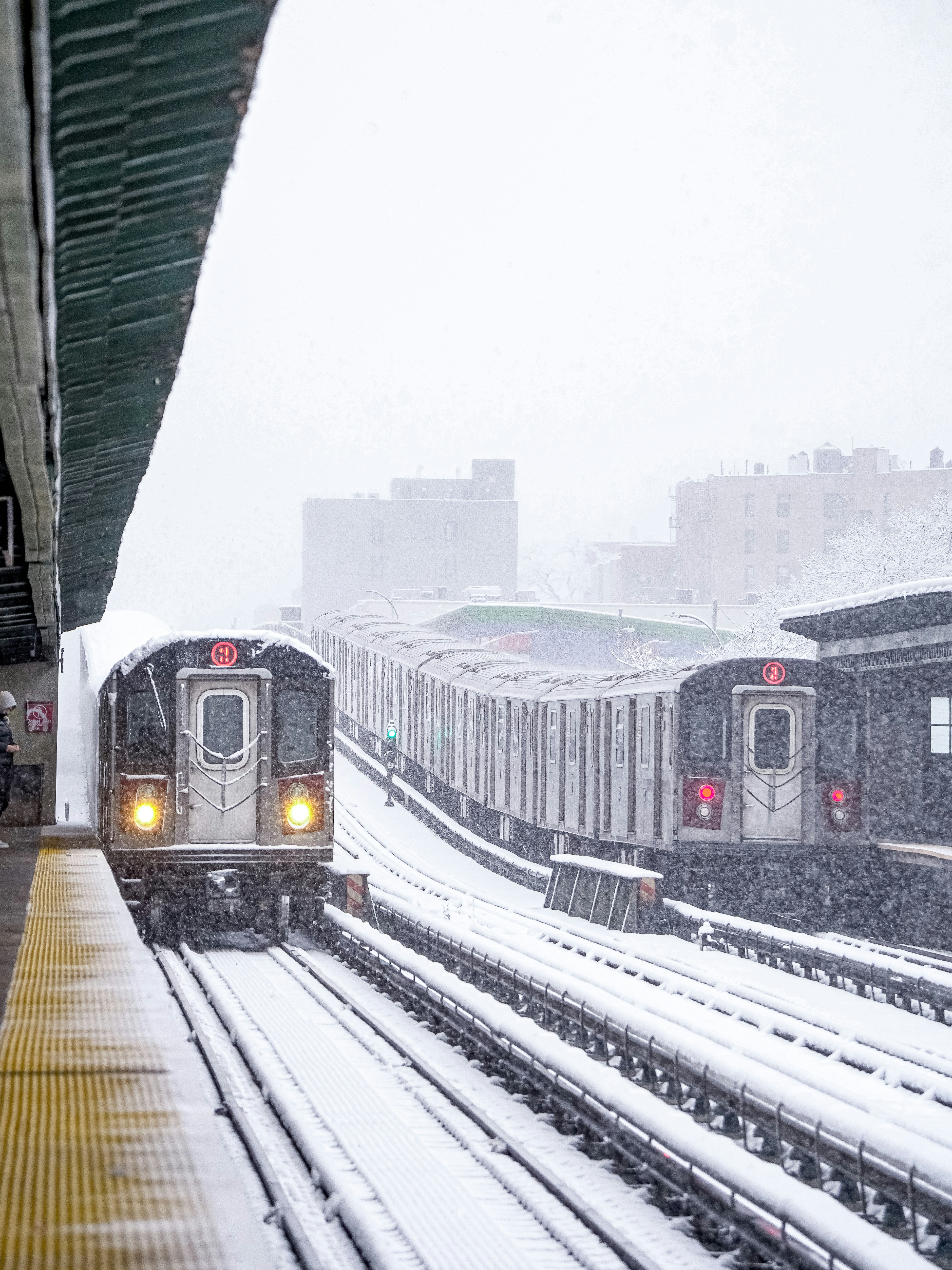 Snowy Subway Convergence: Trains Align in a Quiet Winter Evening