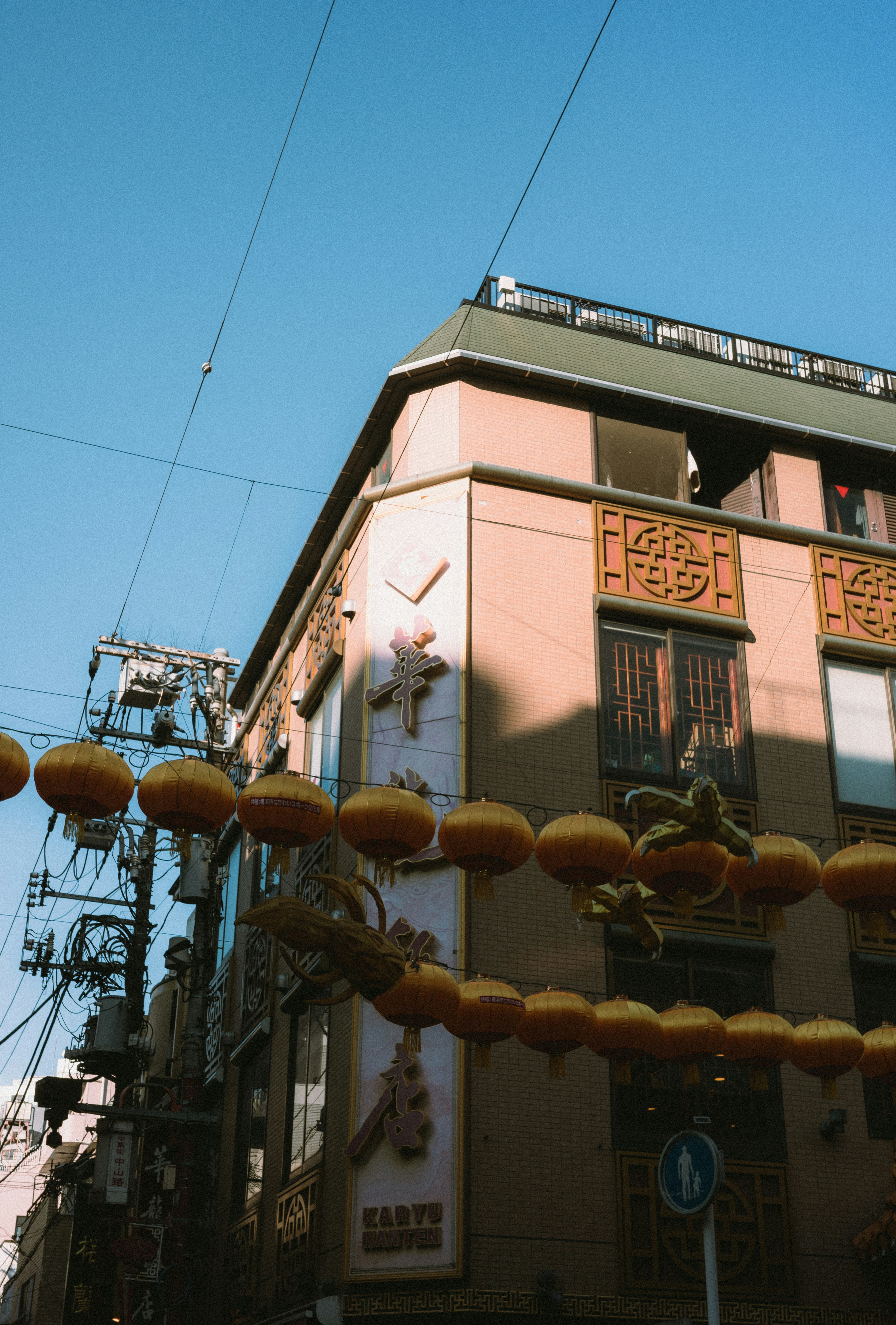  Lantern Strings Over a Sunlit Chinatown Facade