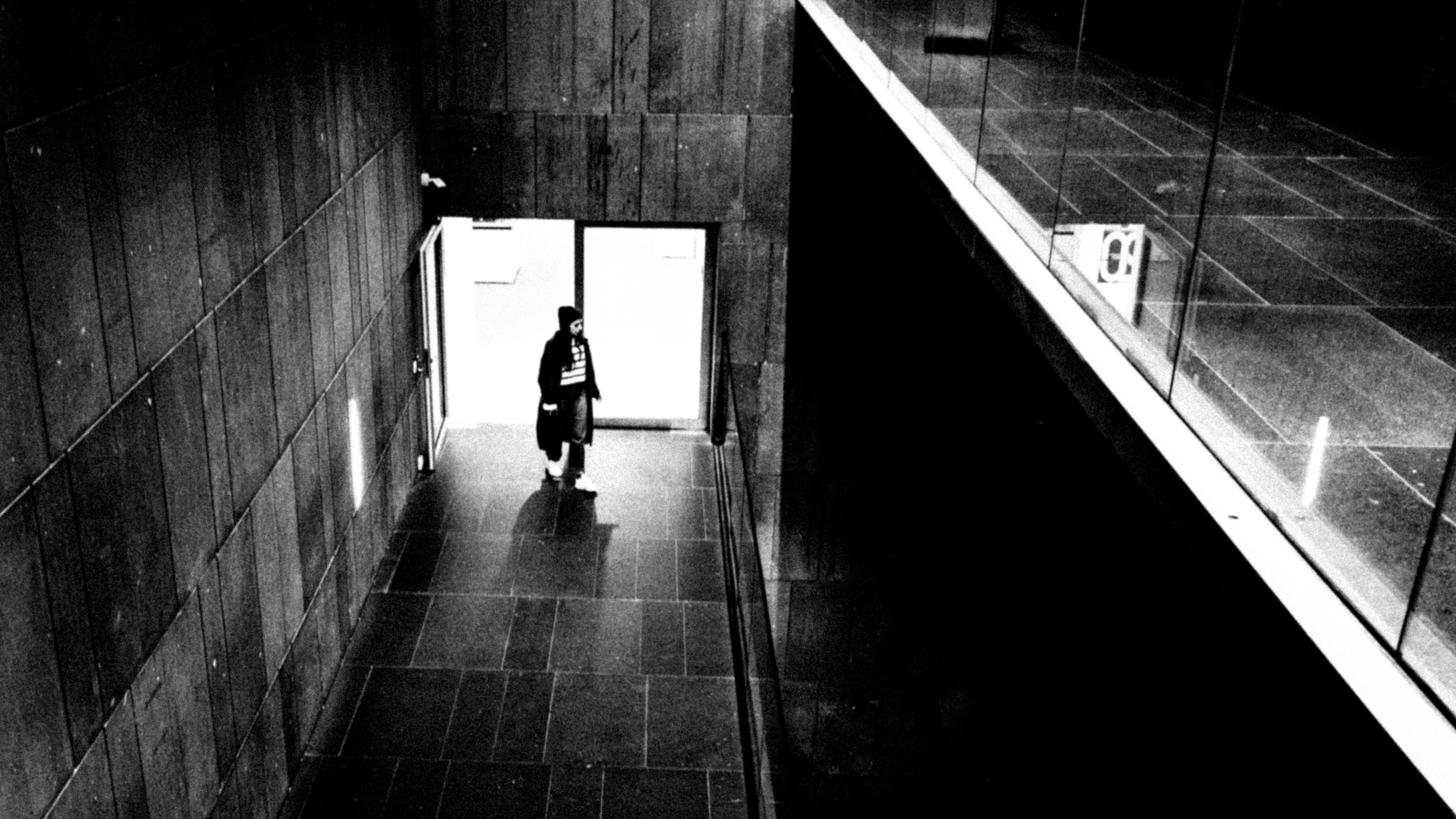 A lone figure walks towards a bright exit photo – Free Architecture ...