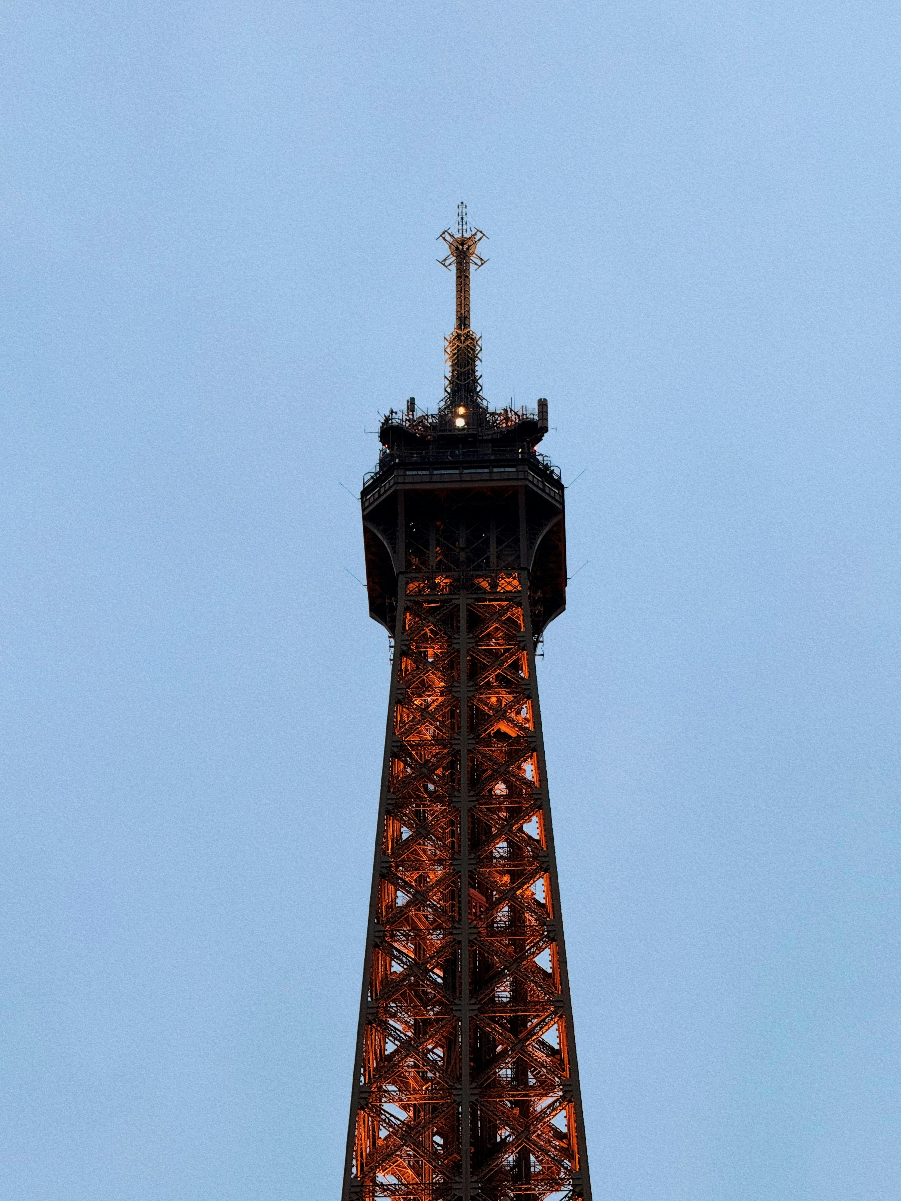 Iron Lattice Rising: City Tower Reaching the Evening Sky