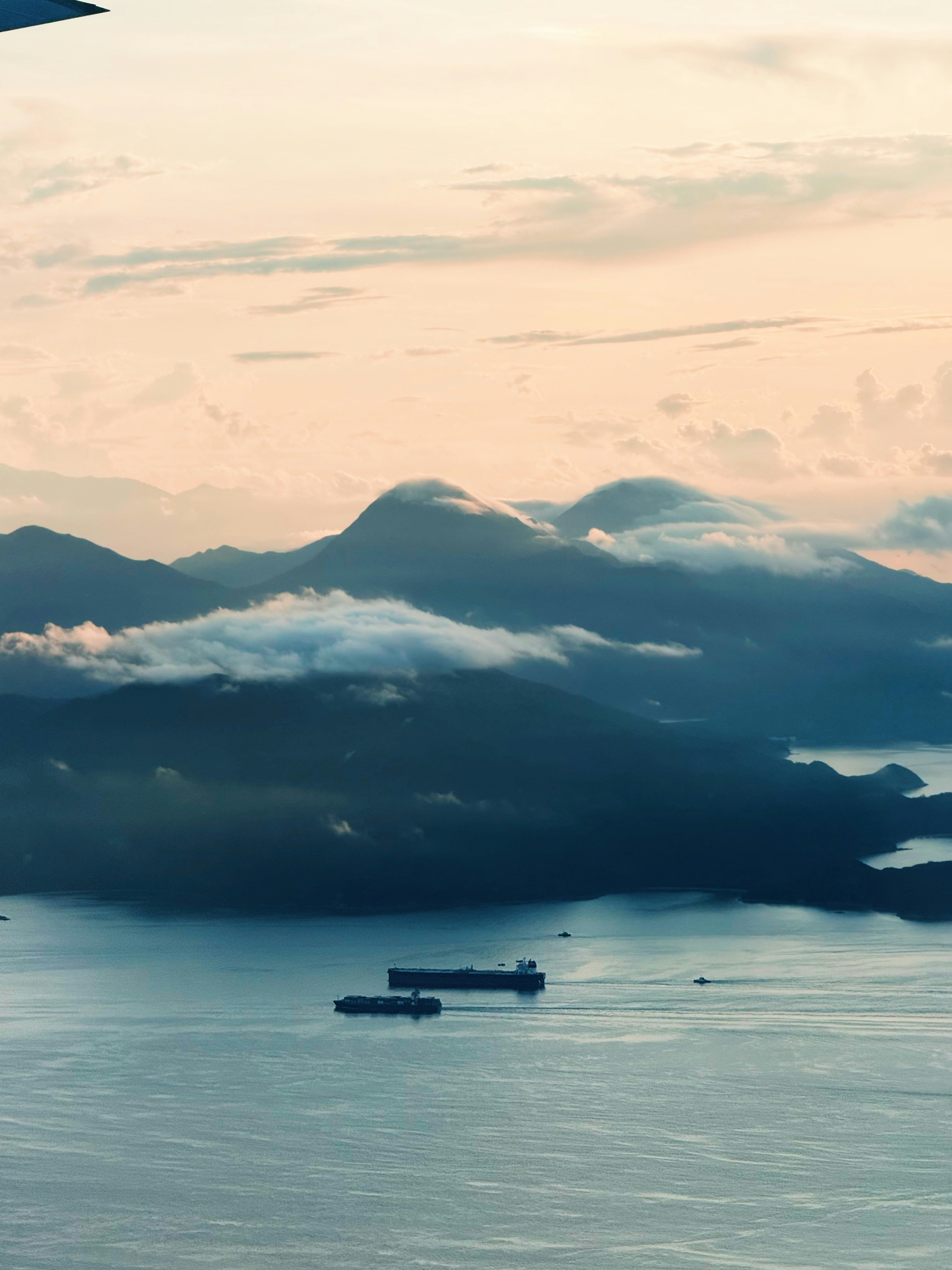 Mist‑kissed Islands: Ships at Rest Beneath a Dawn–Hued Skyline