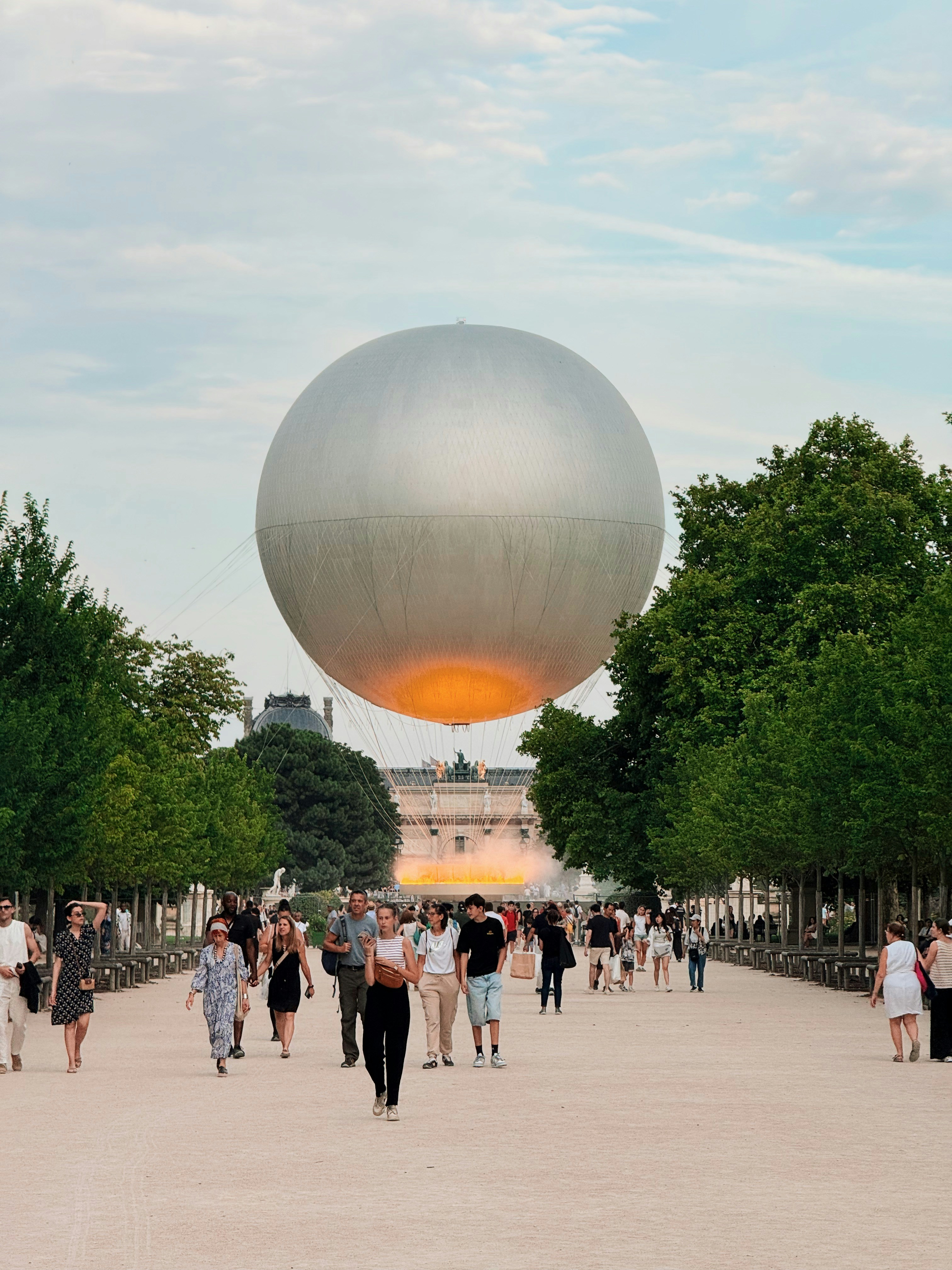 Orbiting Sphere Over the Louvre Courtyard Crowd