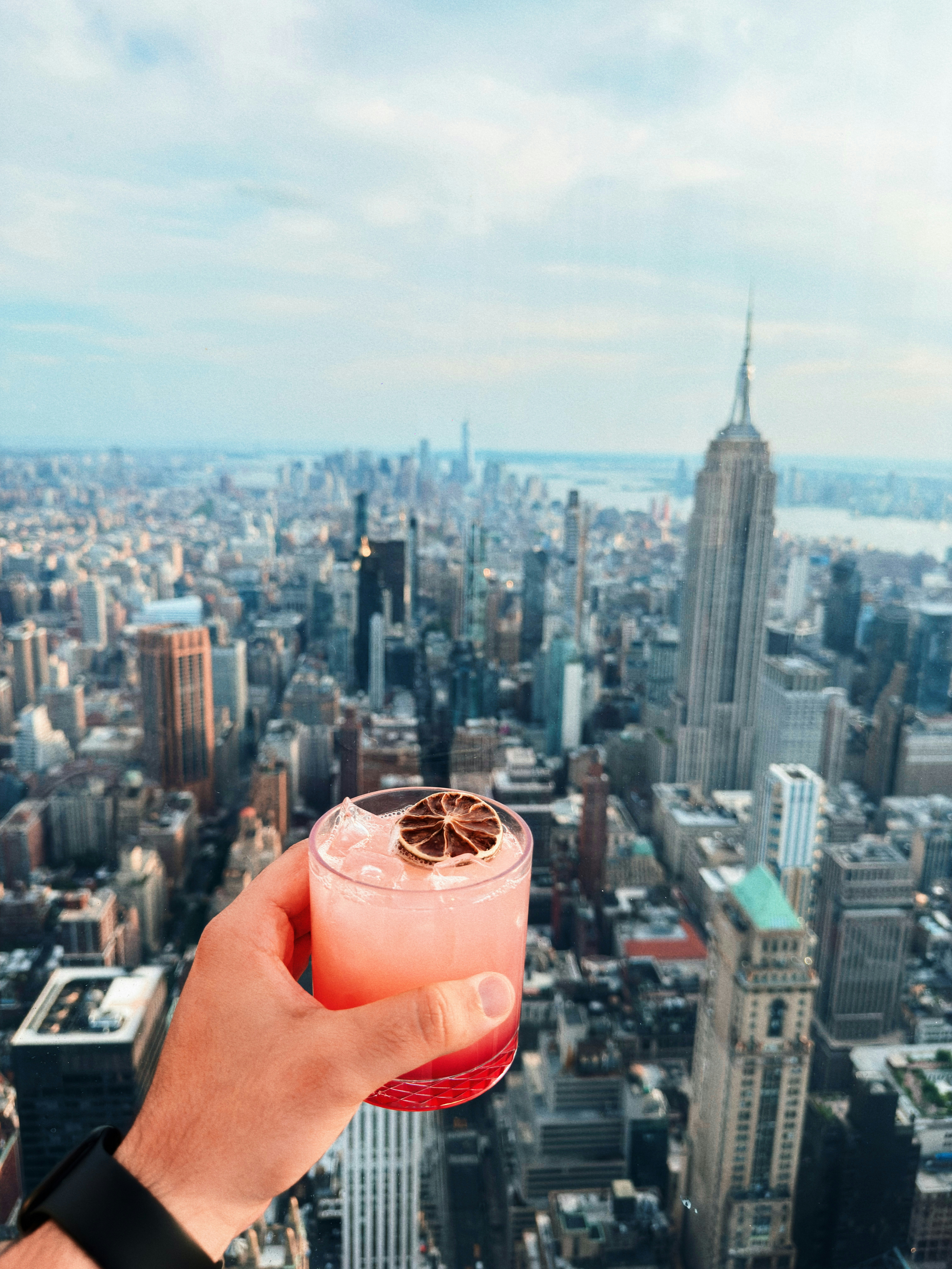 Cityscape Toast: A Sunset Sip Above Midtown