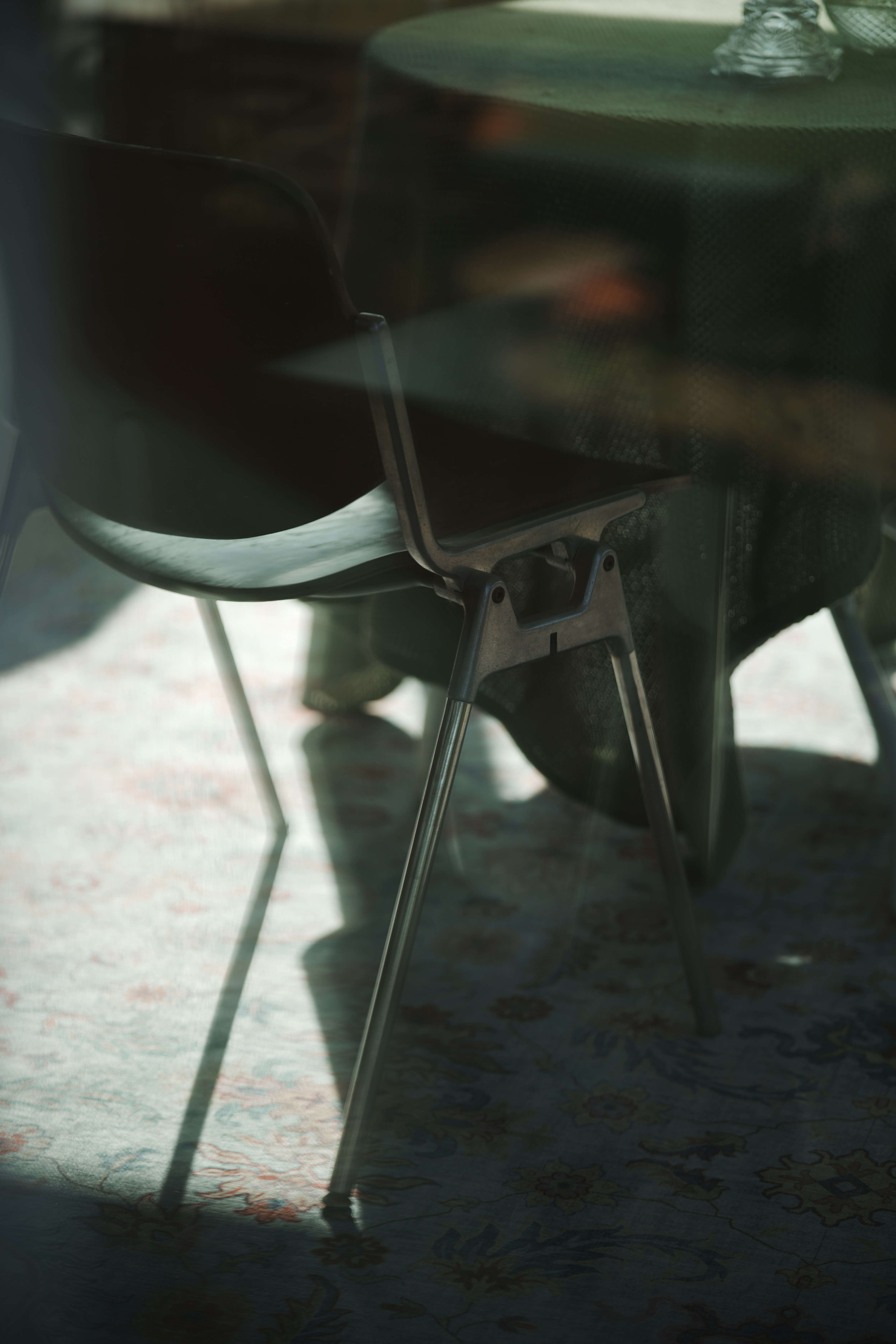 Shadowed Chairs and Glass Table in Dim Indoor Light