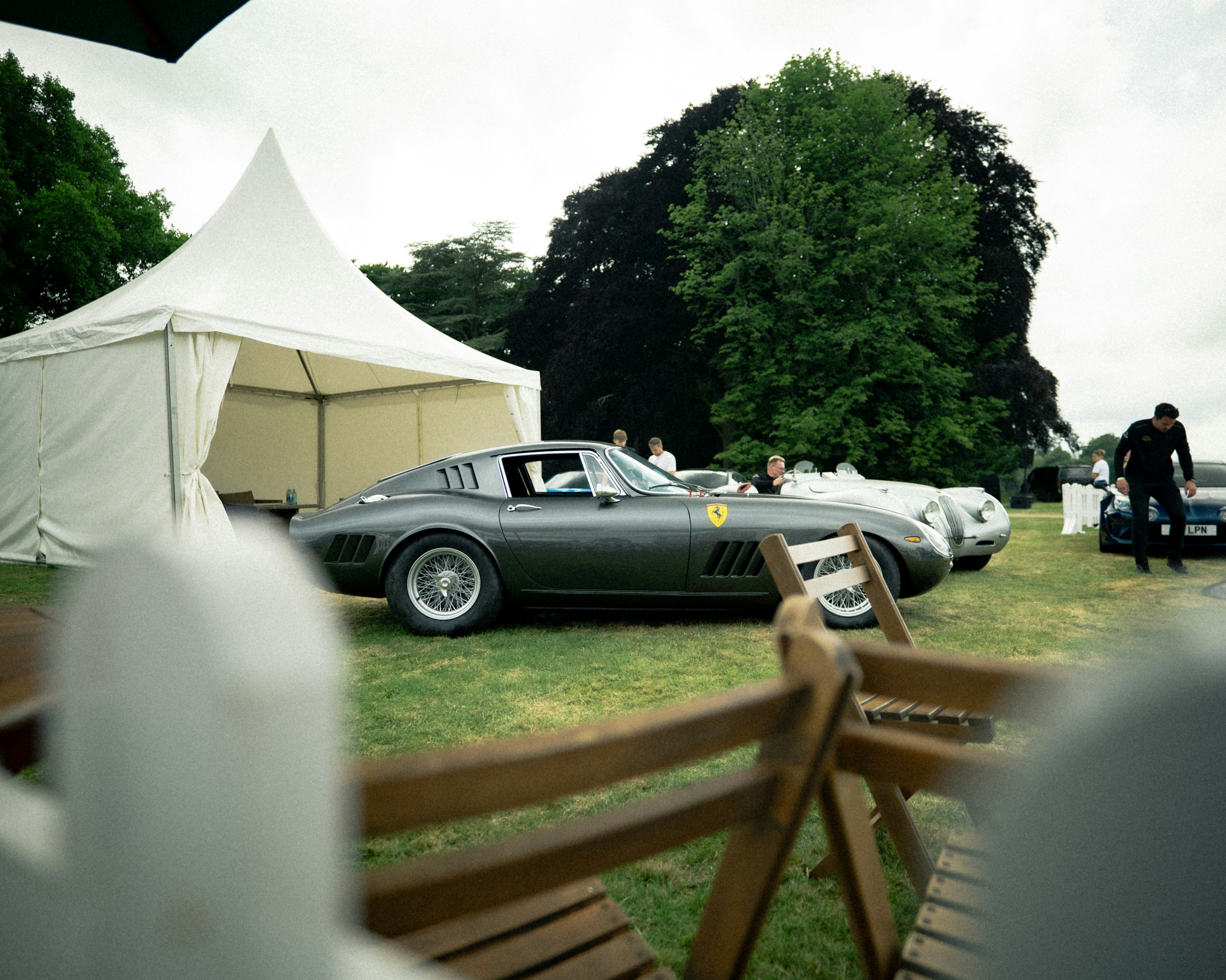 A classic Ferrari vintage sports car photographed at an outdoor car show, showcasing elegant Italian design, wire wheels, and timeless automotive craftsmanship. This image represents luxury automobiles, classic car culture, racing heritage, and retro sports car design, captured in natural daylight at a concours-style event.