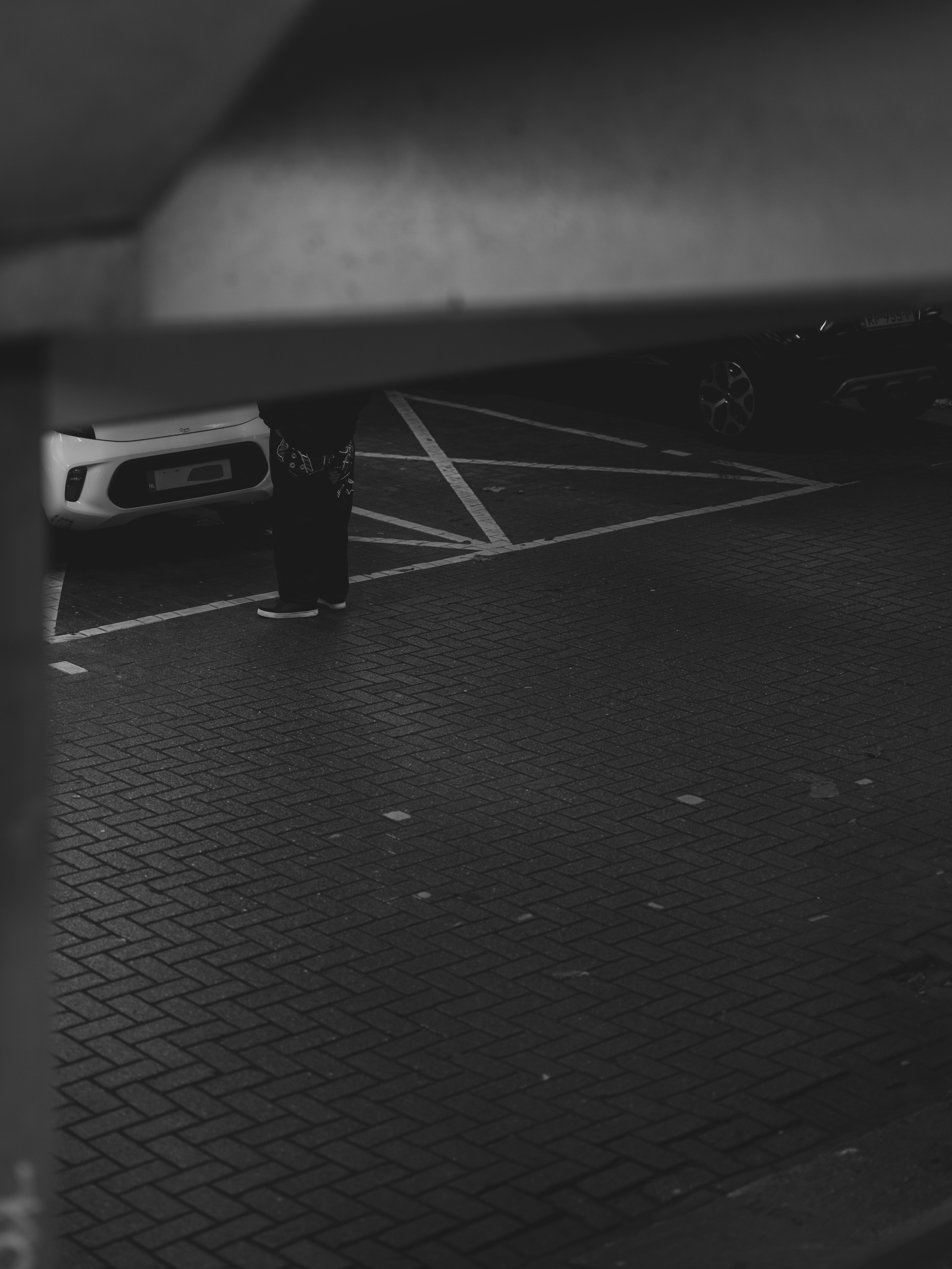 Hidden Figure at the Edge of the Parking Shade