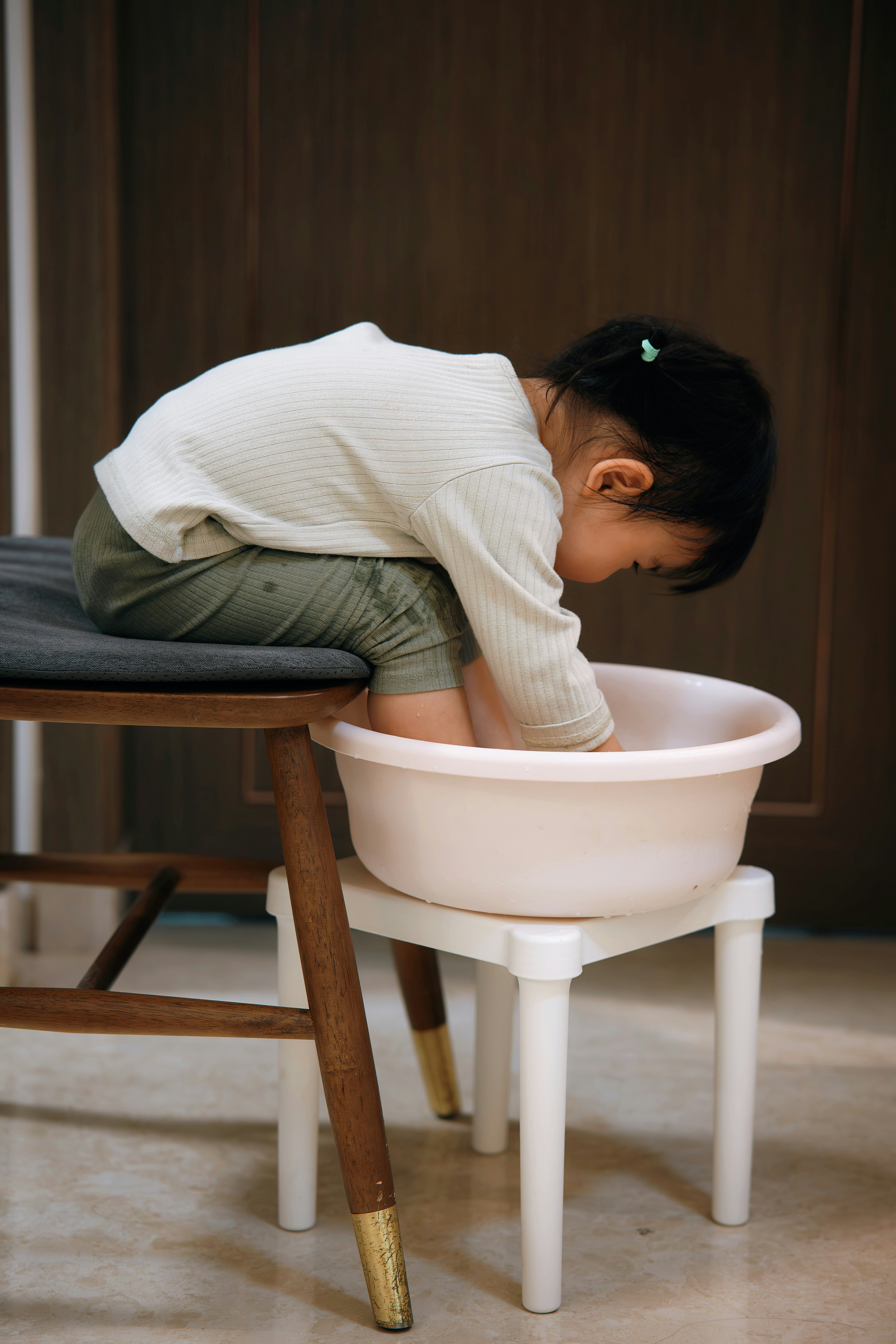 Curious Moment: A Toddler Dips Hands into a Basin