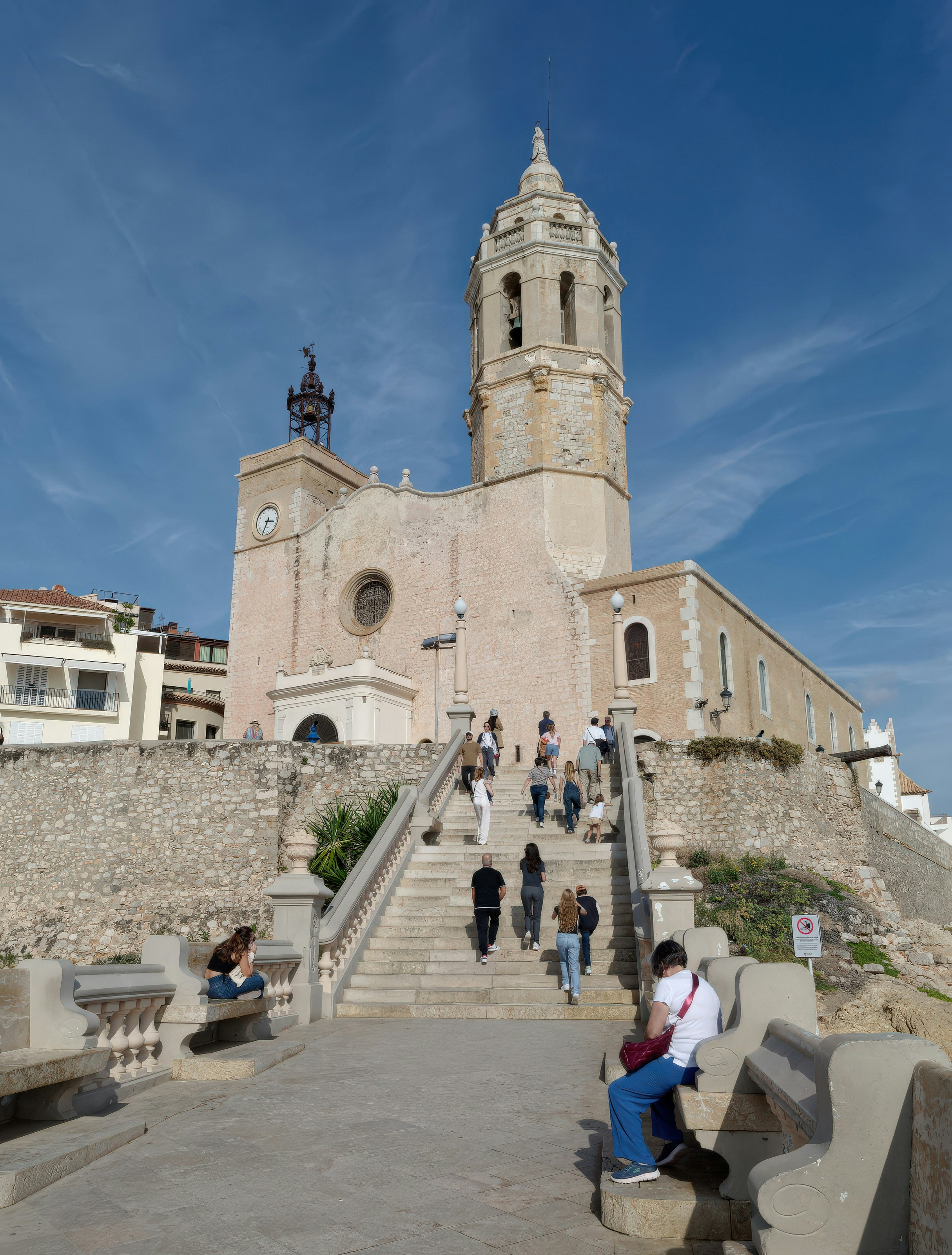 Steps to the Sunlit Church: A Mediterranean Staircase to a Towering Facade