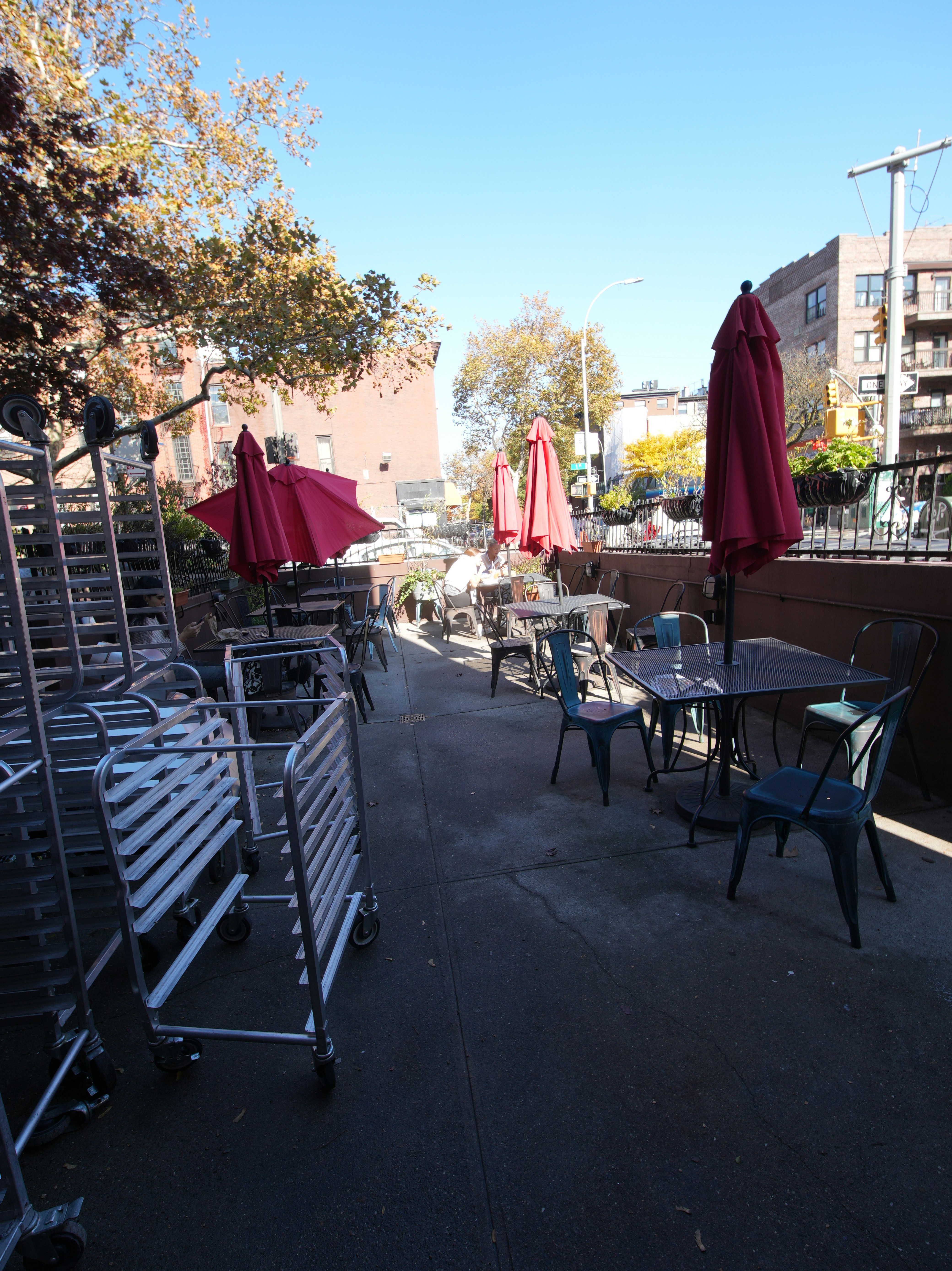 Sunlit Courtyard Café—Umbrellas, Chairs, and Urban Quiet