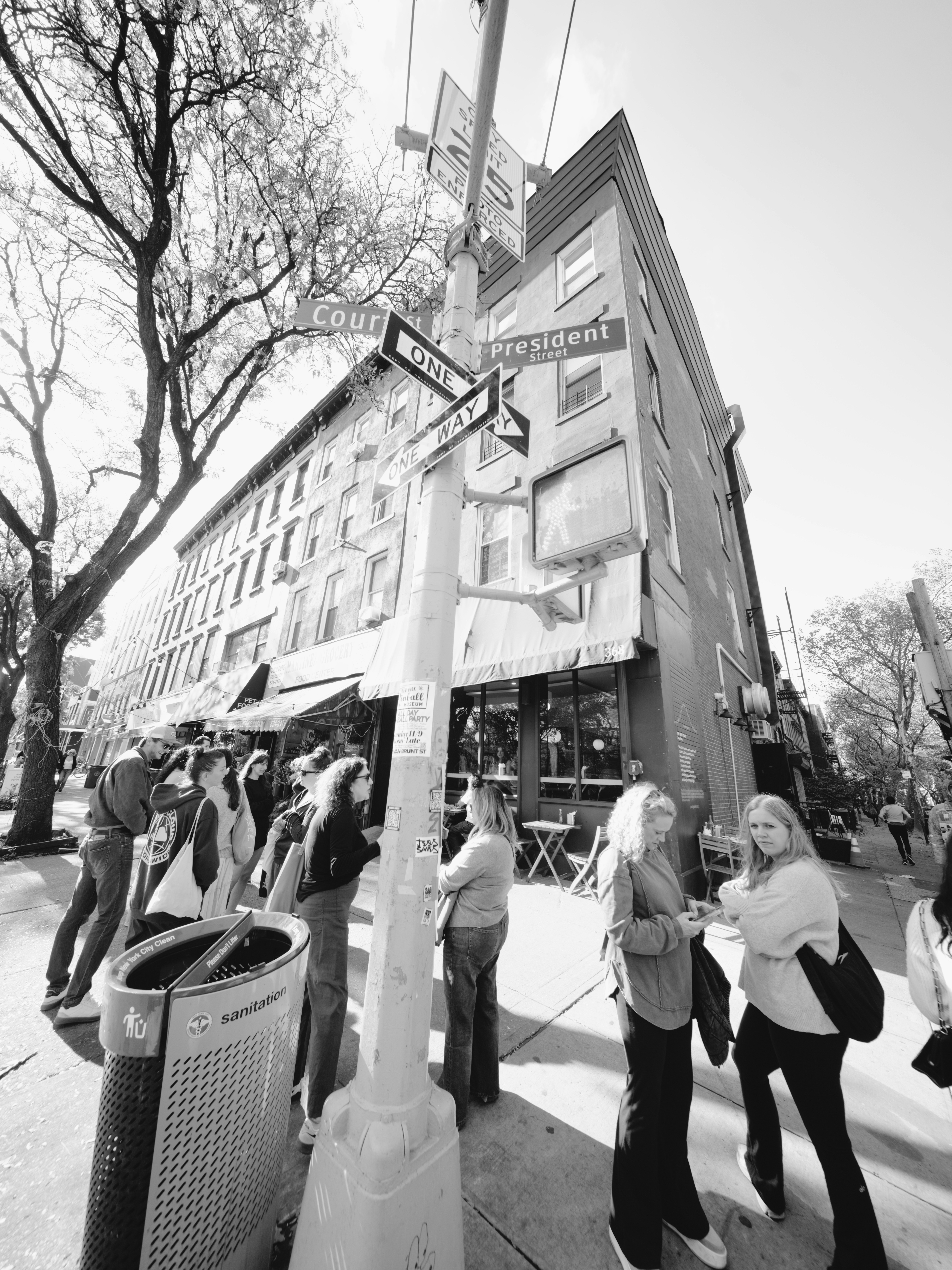 Crosswalk Corner: A Cornerstone Street Scene by the Metro Sign