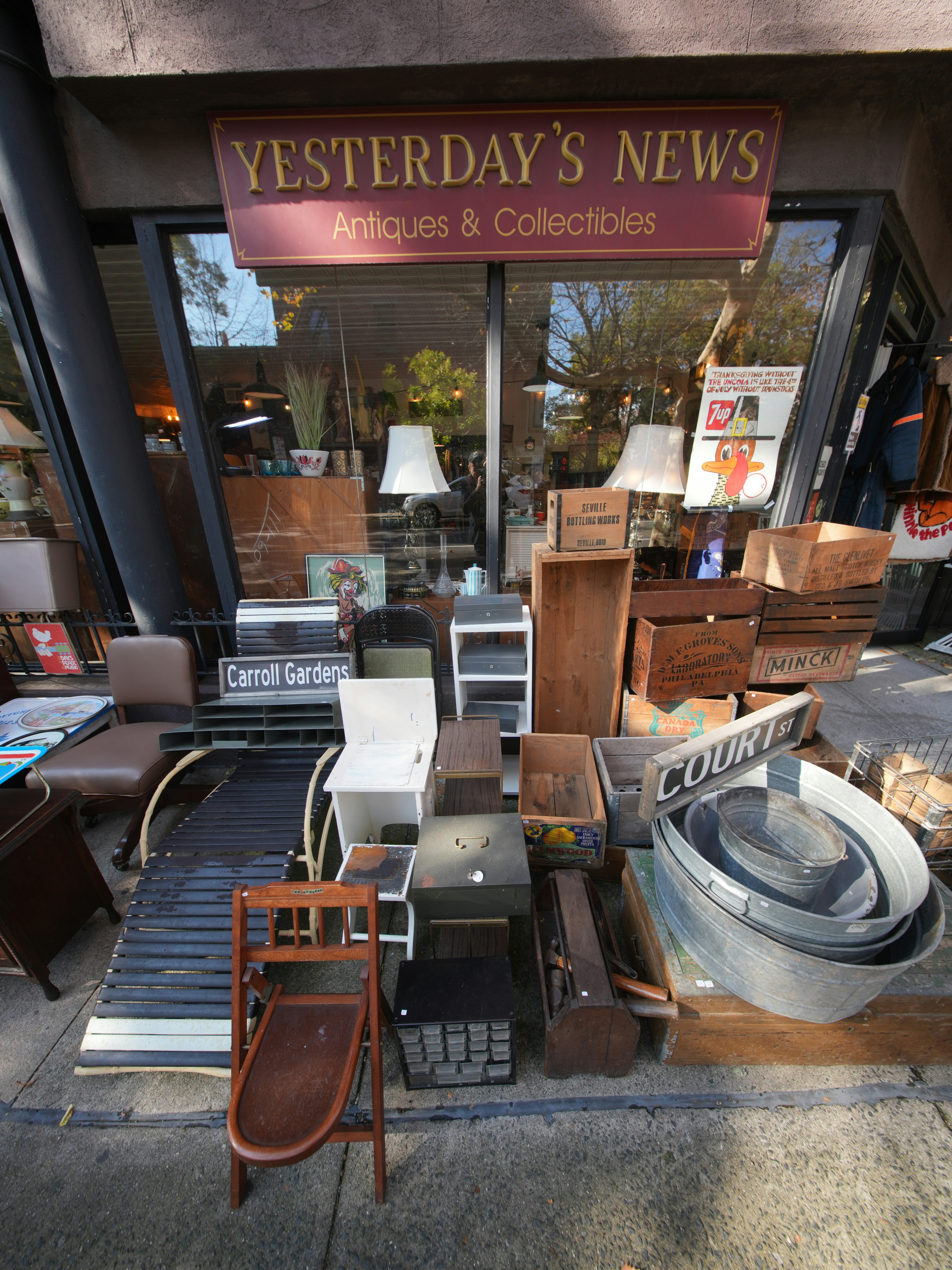 Antique Treasures Spill Across the Sidewalk in Front of Yesterday's News