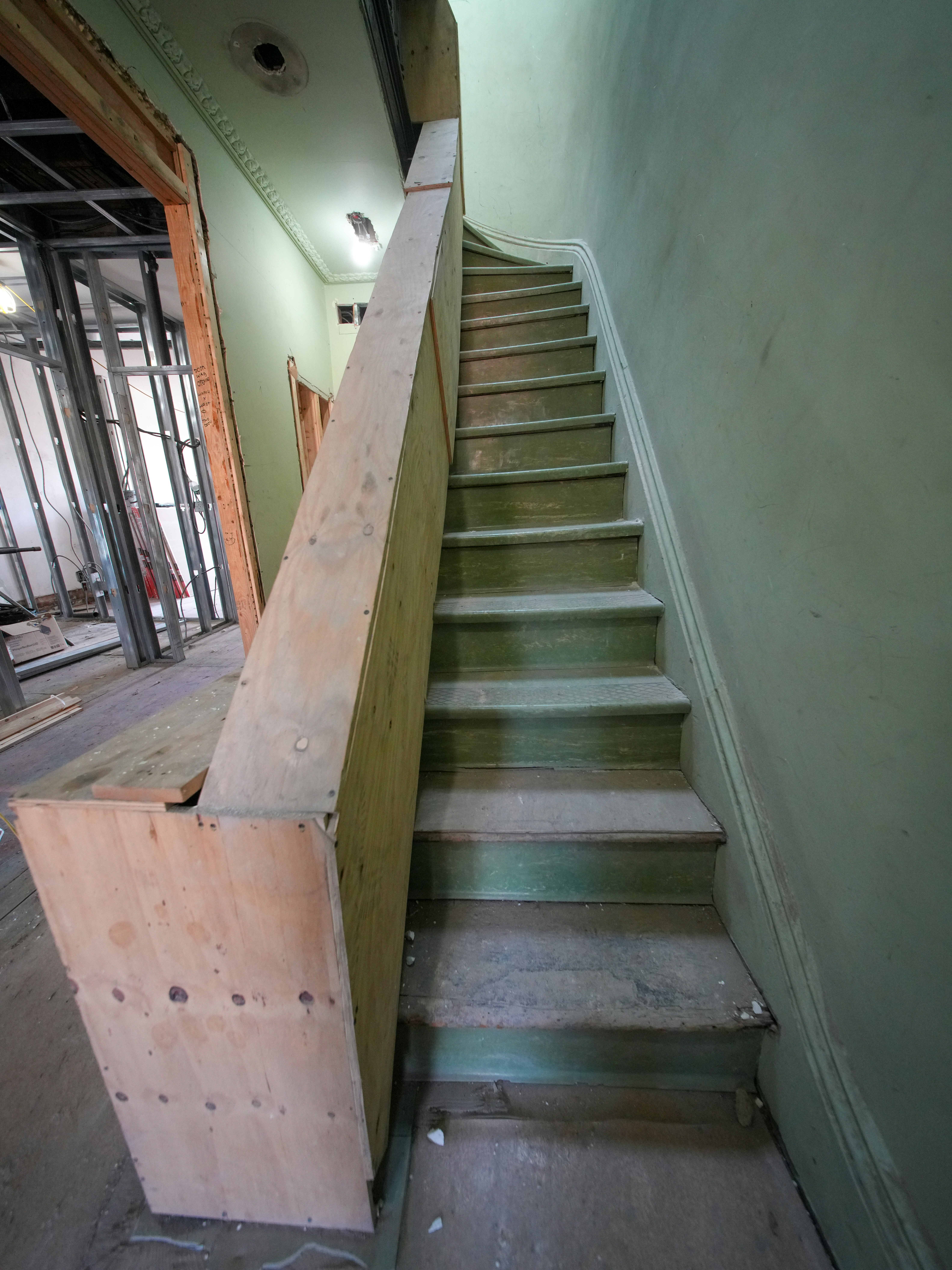 Green Staircase Under Construction: A Glimpse into an Unfinished Interior