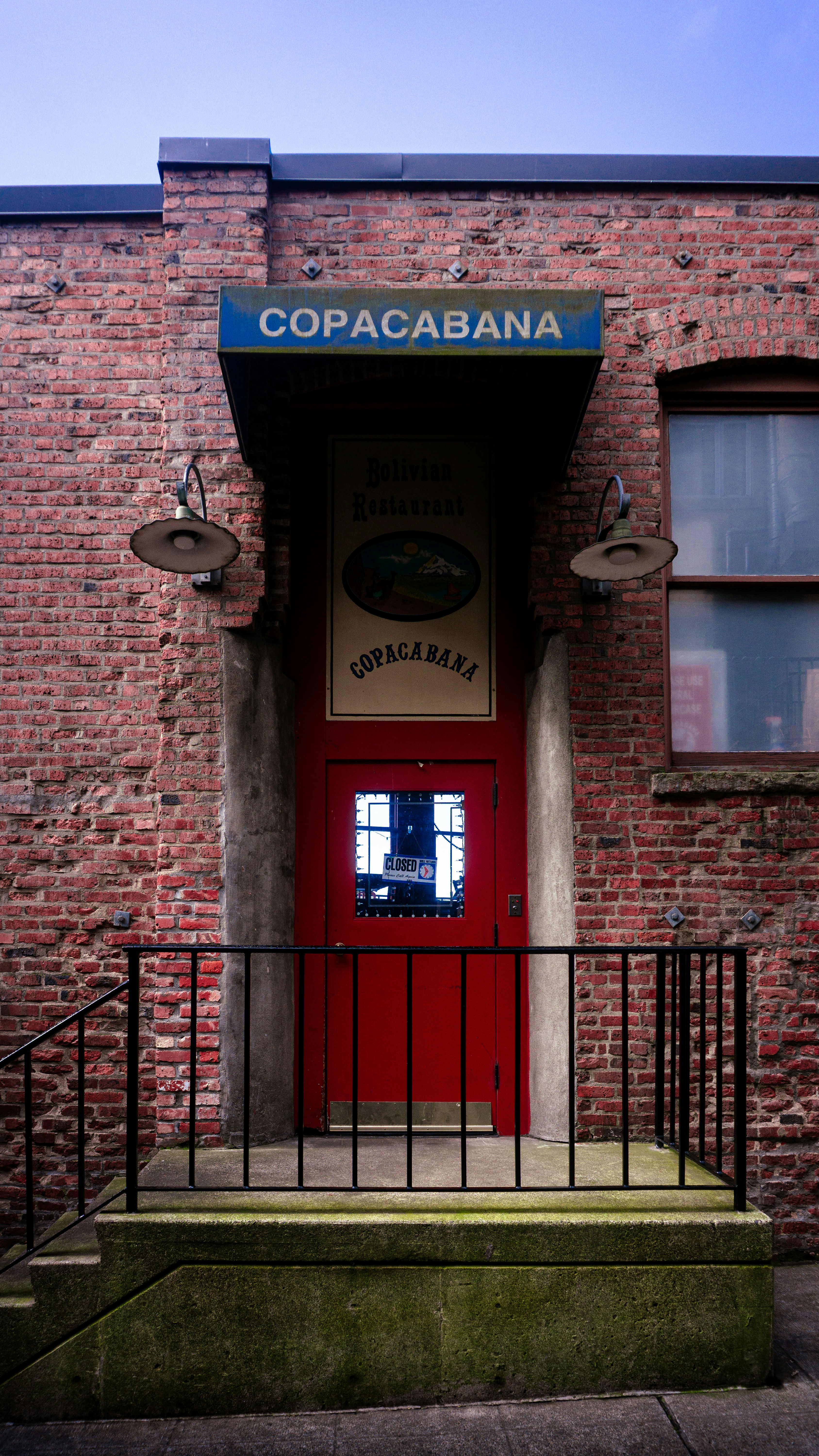 Red door with copacabana sign on brick building photo – Free Building ...
