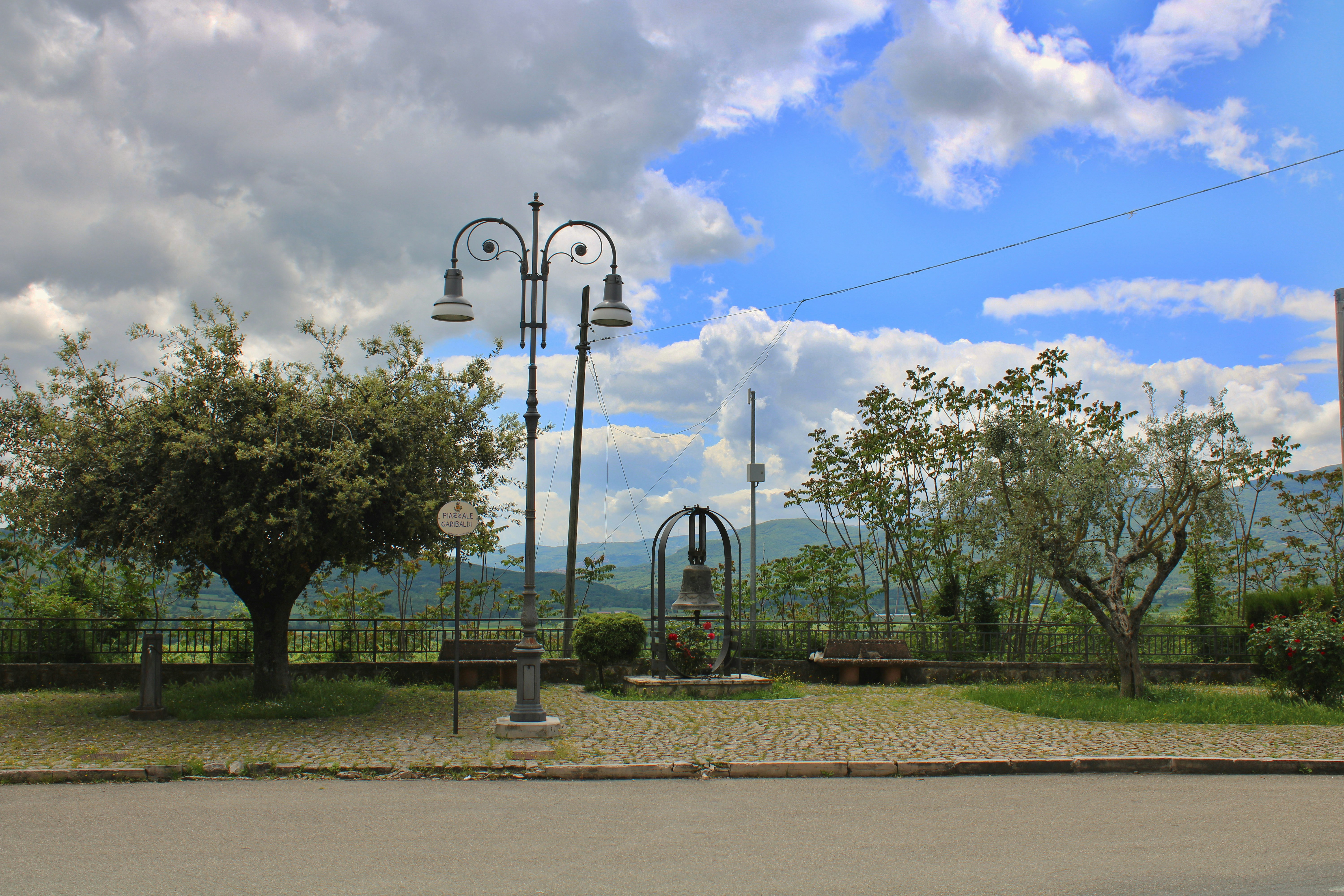 Lamps, Arch, and Bench by the Scenic Riverfront