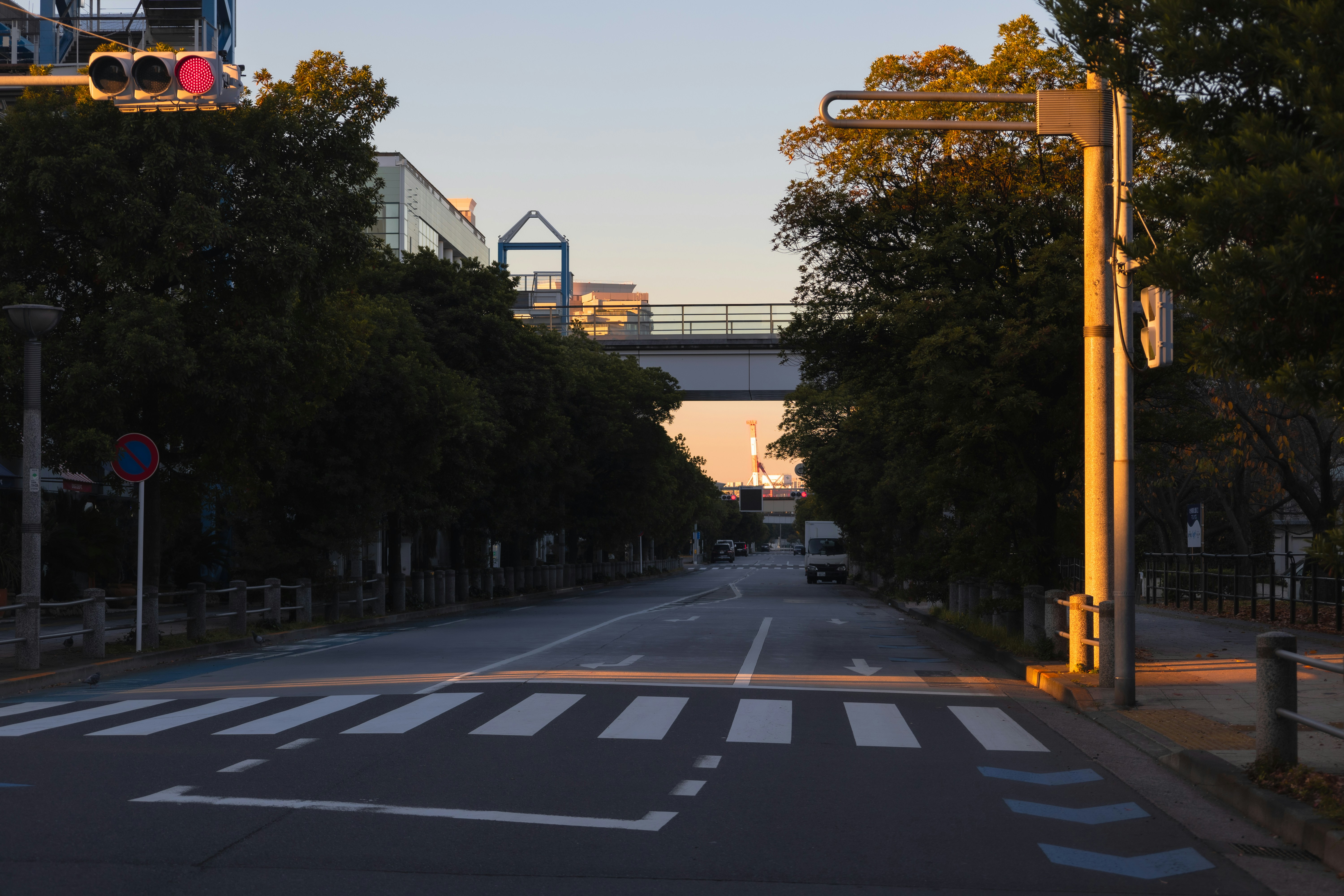Dawn on an Empty City Street Framed by Shadows and Railings