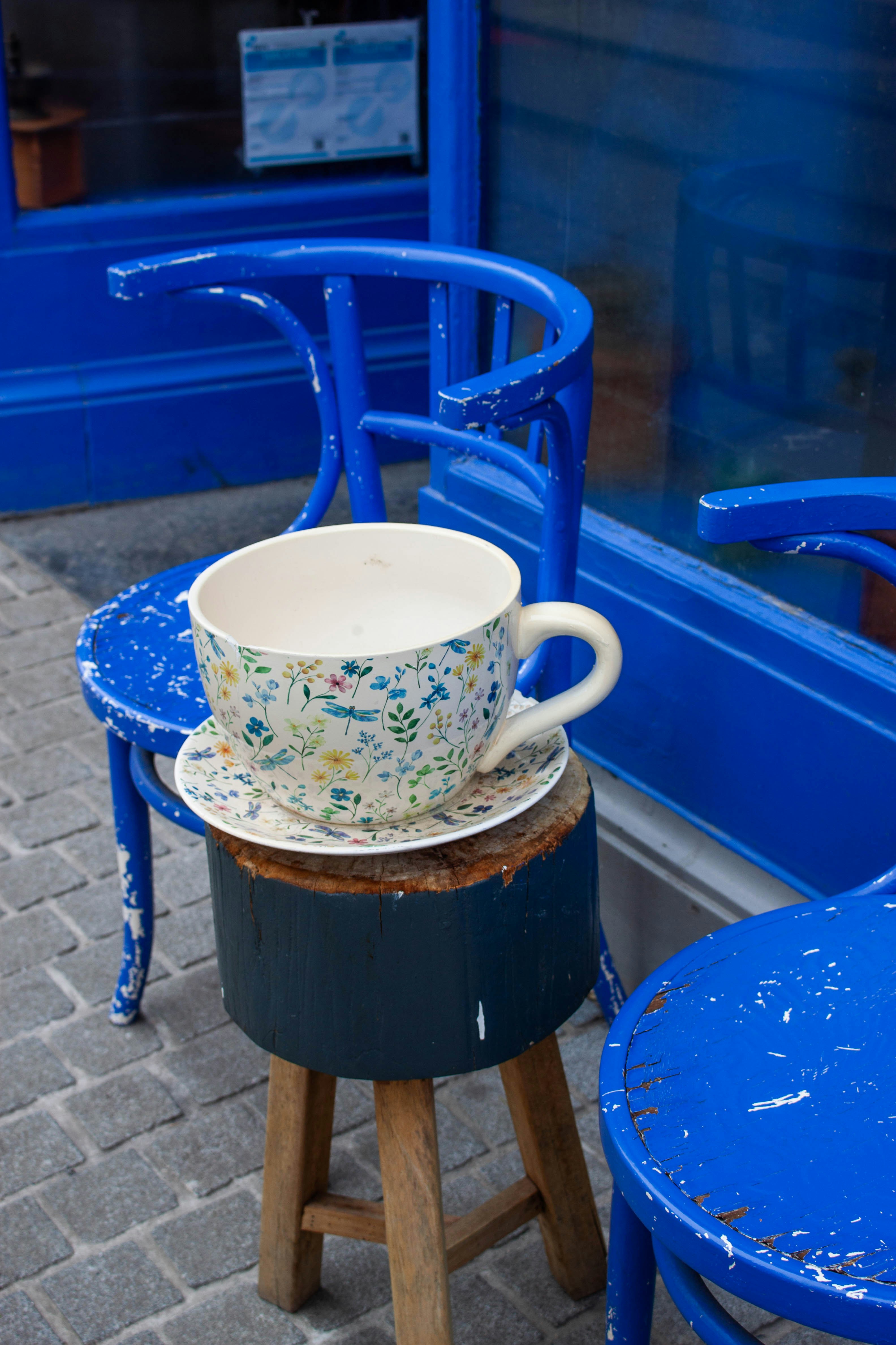 Blue Café Corner: Tea Cup on a Weathered Stool