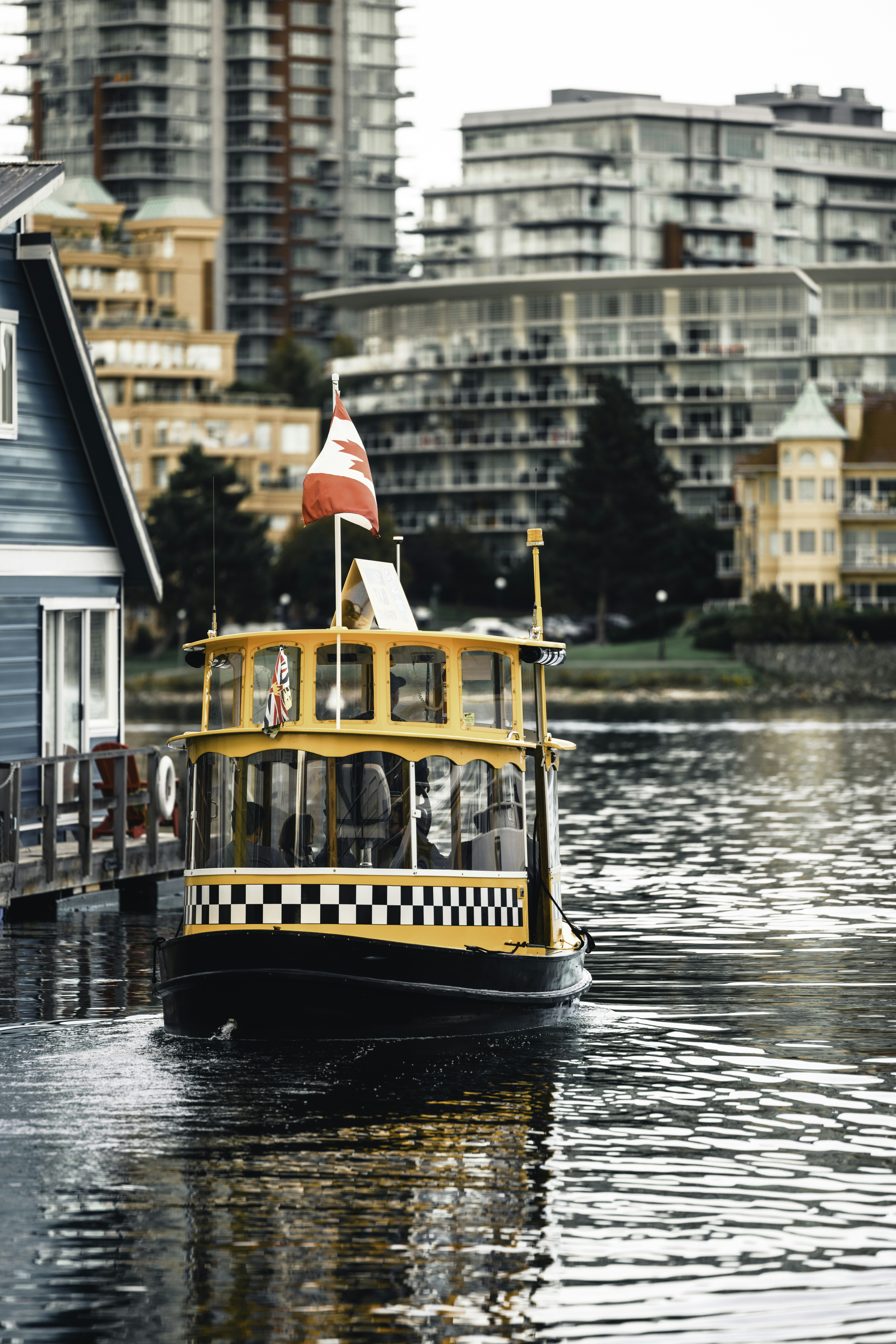 Yellow Harbor Taxi: A Ferry Boat’s Quiet Journey Past Modern Towers