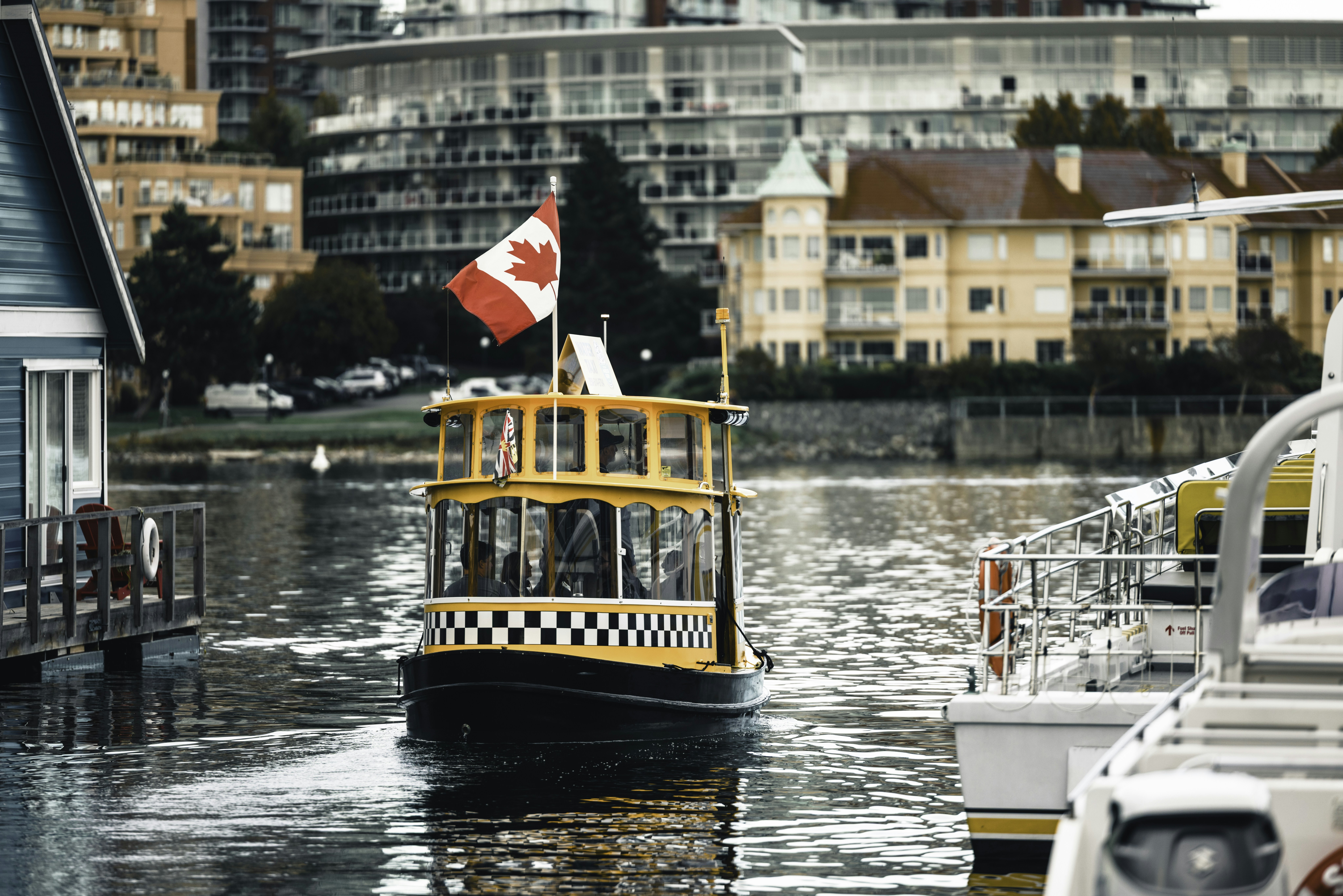 Canadian Flag on a Harbor Taxi: A Quiet River Moment