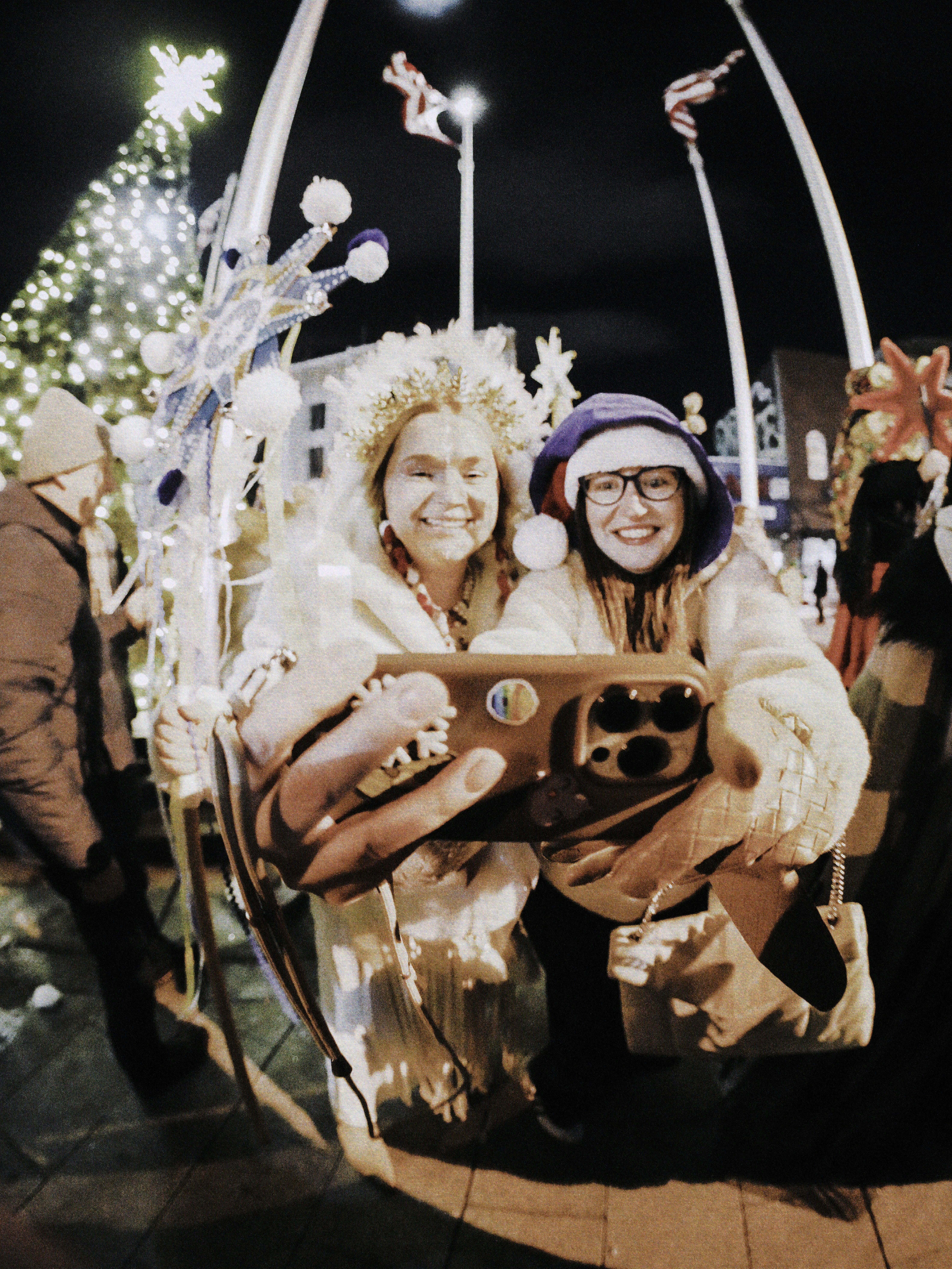 Two Joyful Selfie Seekers at a Festive Night Market