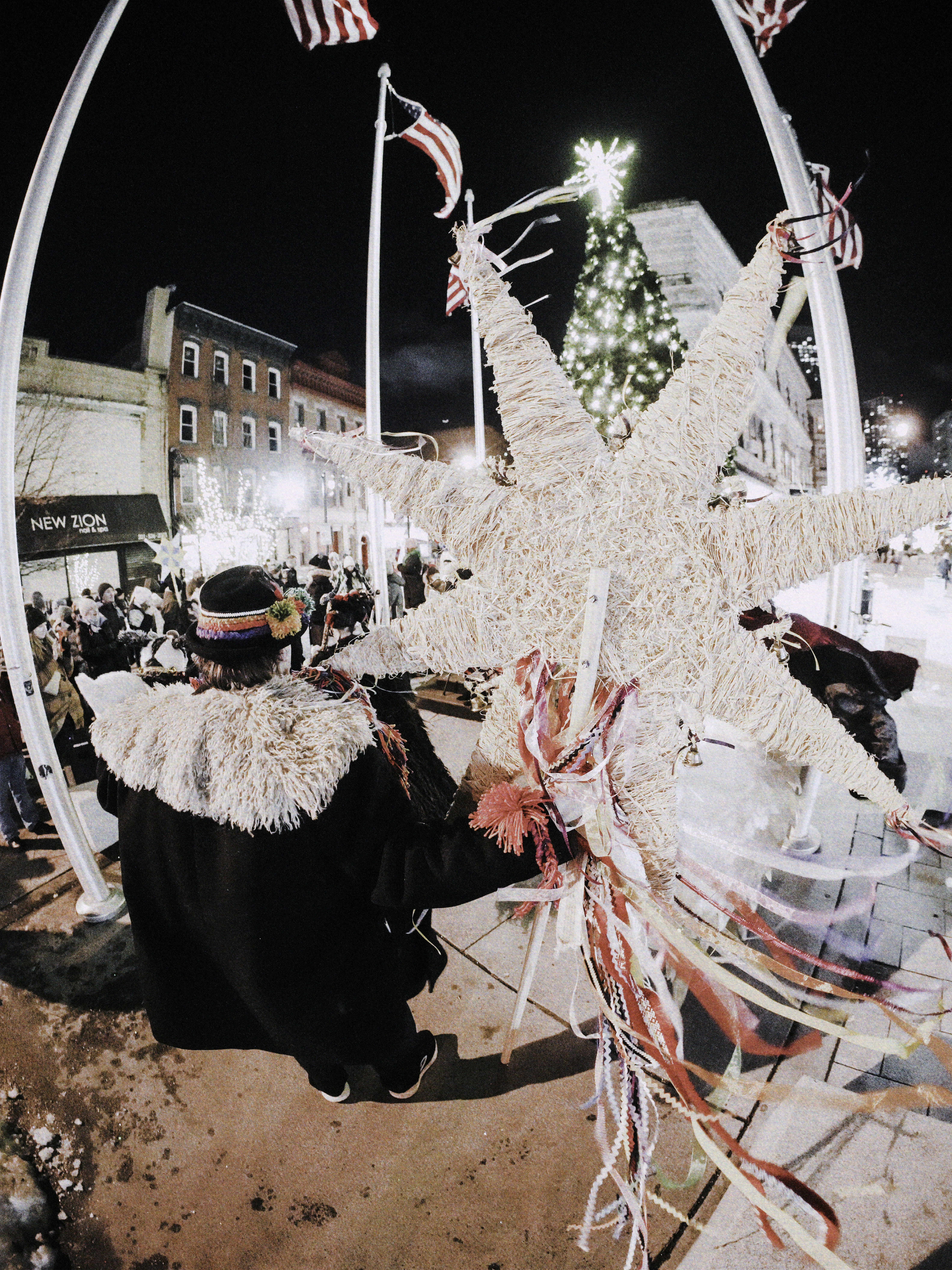 Starry Yuletide: A Leaning Spiraled Figure Amid Holiday Night Market