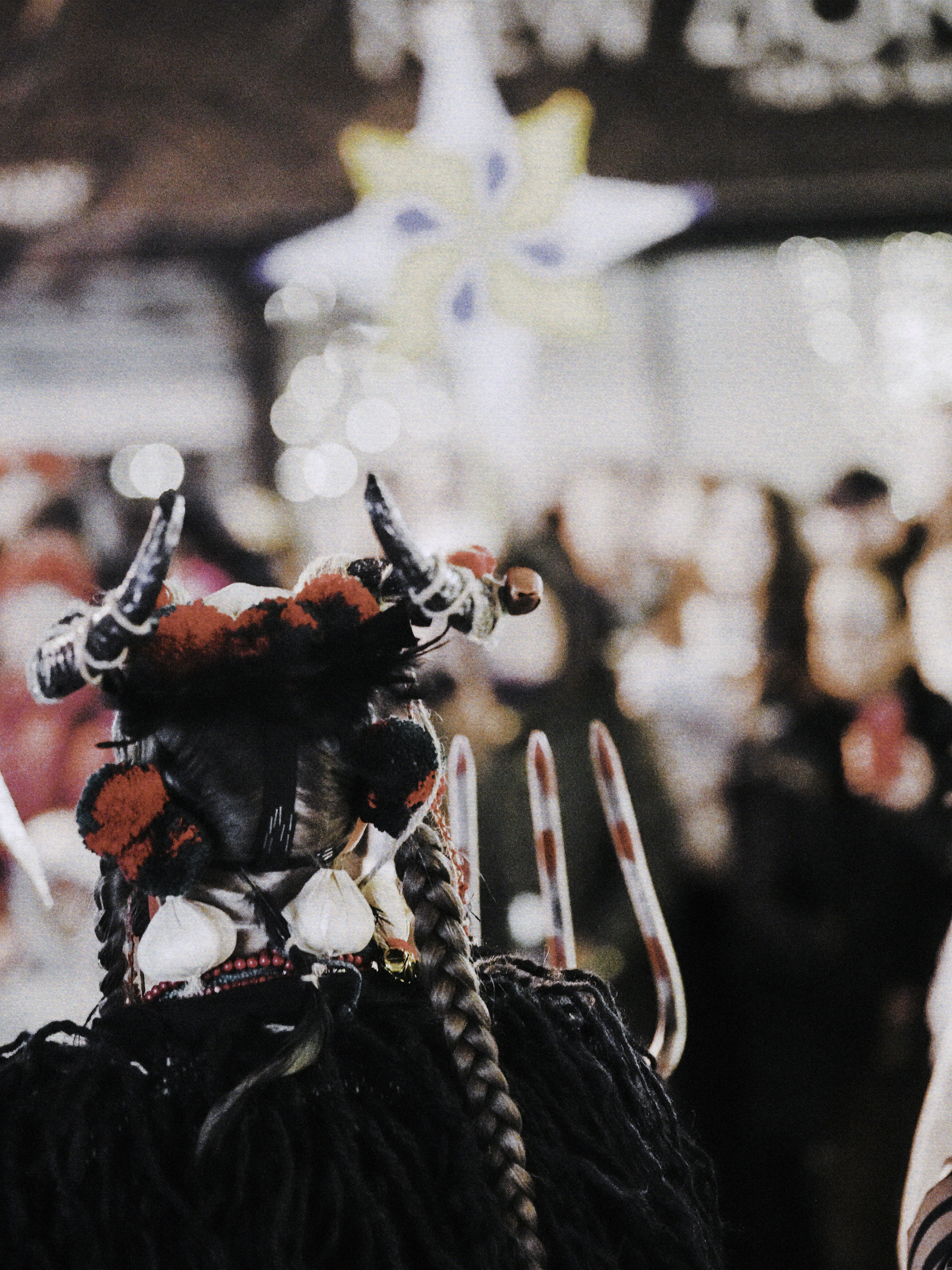  horns and braids in motion: a masked performer at a festive market