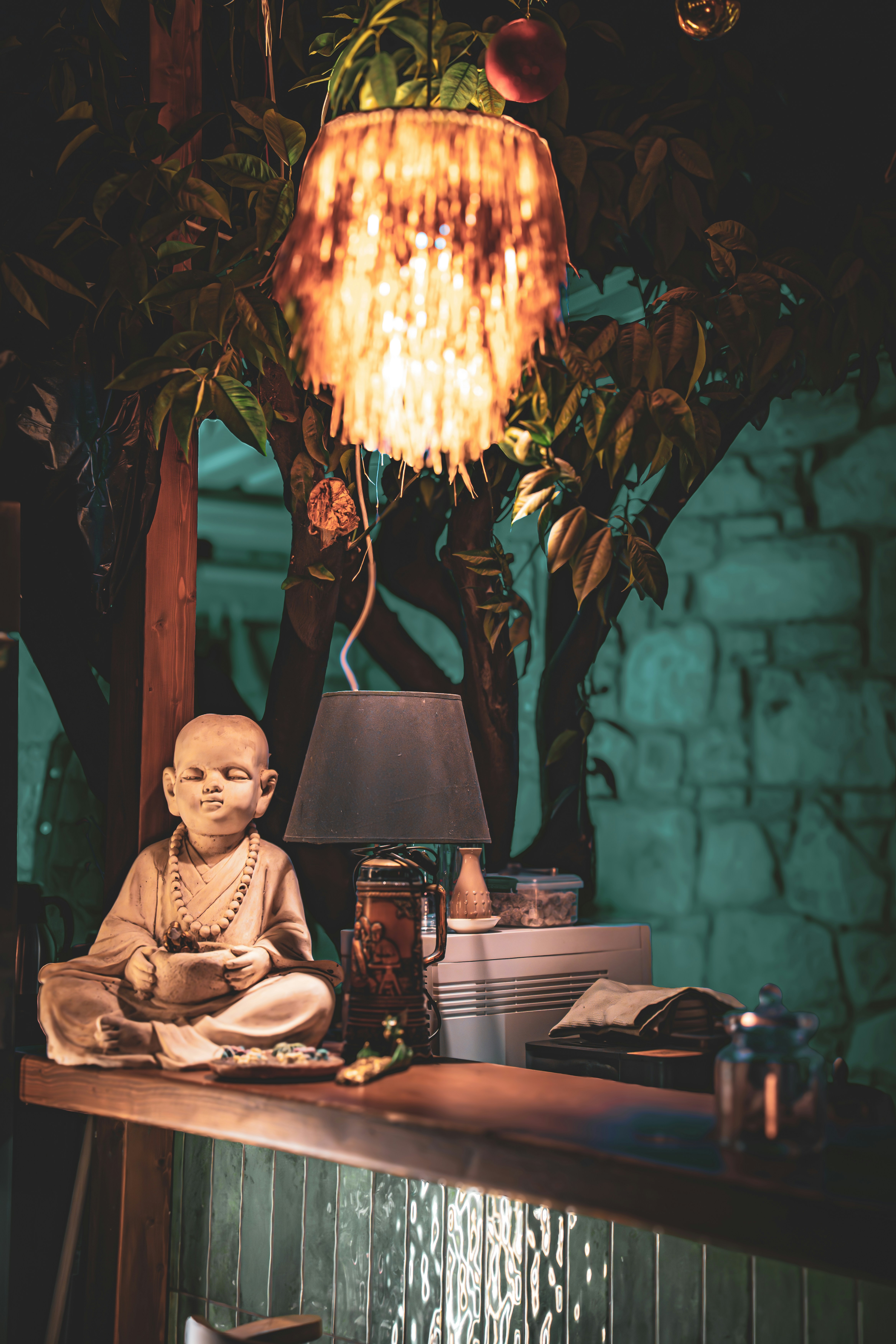 Silent Monk at the Glow of a Hanging Lamp